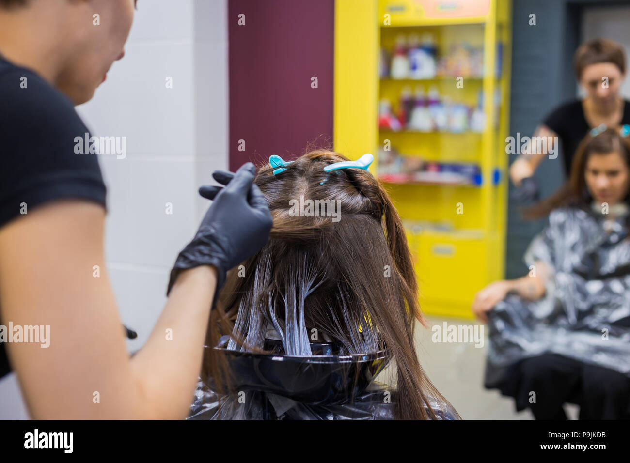 Professional hairdresser, stylist doing hairstyle of female client at ...