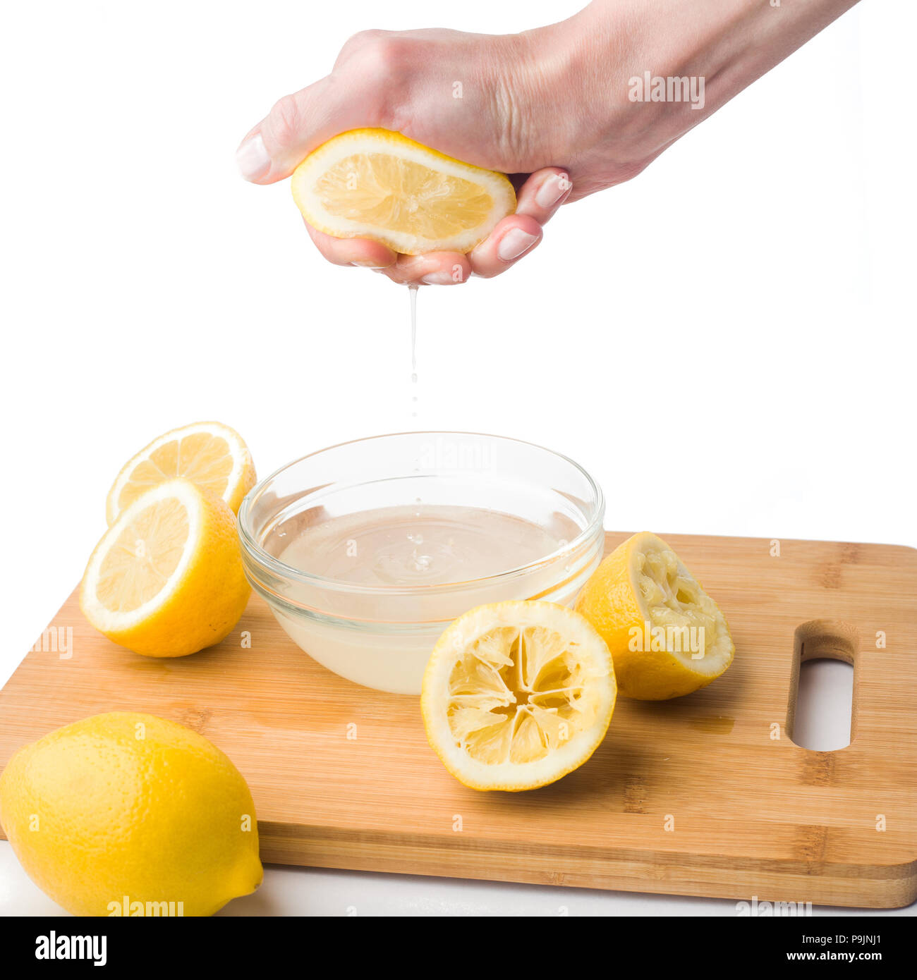 Hand squeezes lemon juice on a white background, isolated Stock Photo ...