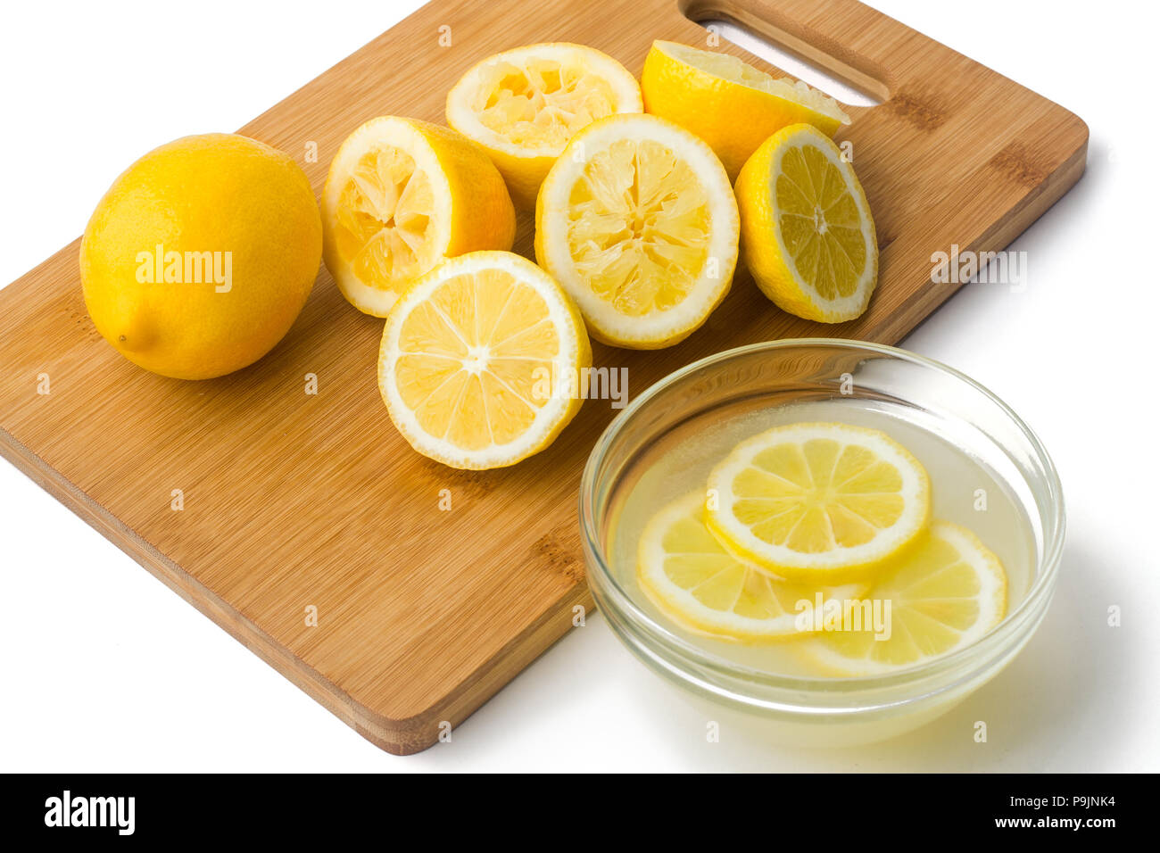 Lemons and juice on white background Stock Photo - Alamy