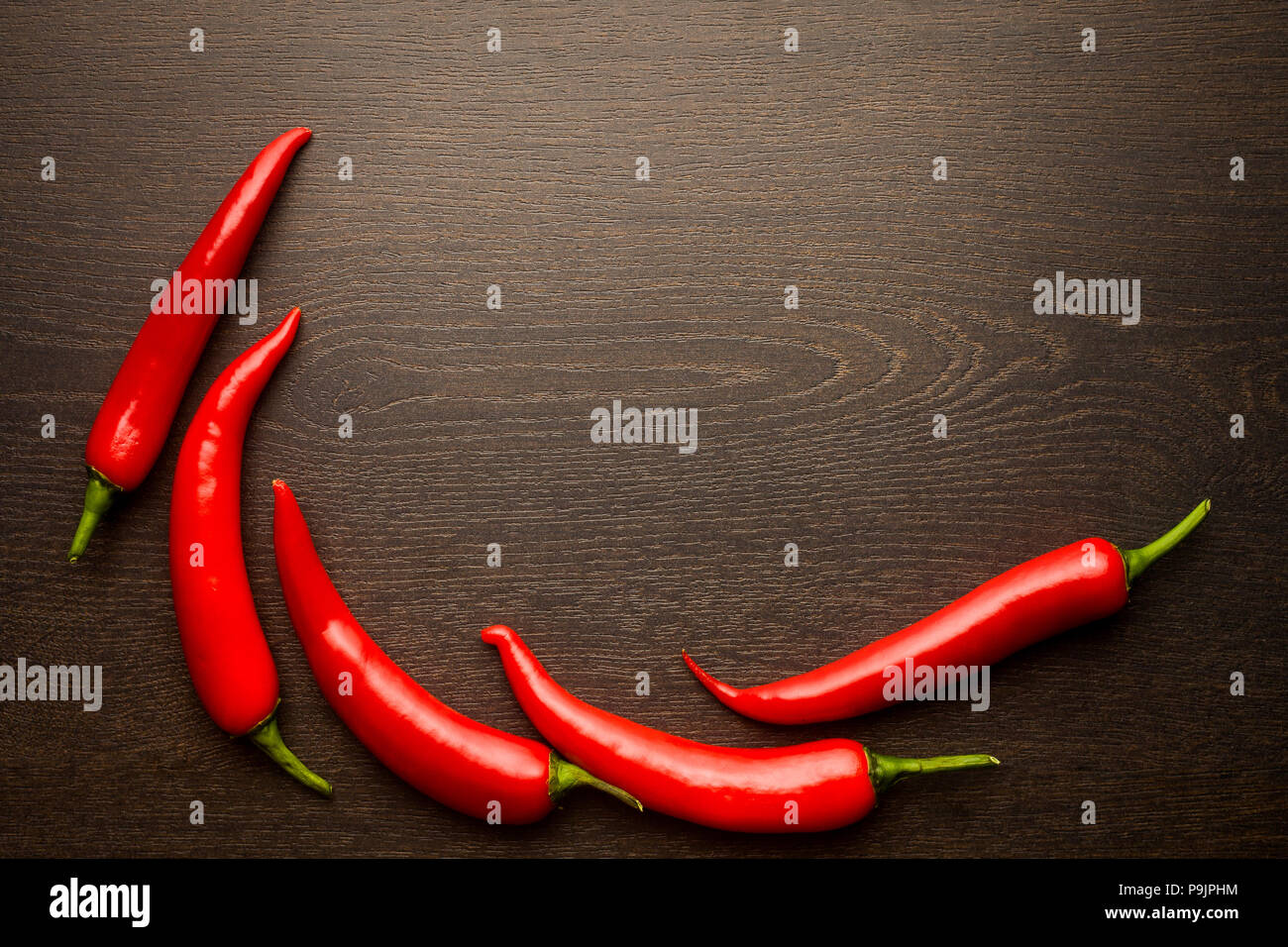bunch fresh raw red hot chilli pepper on a wooden background tie Stock ...