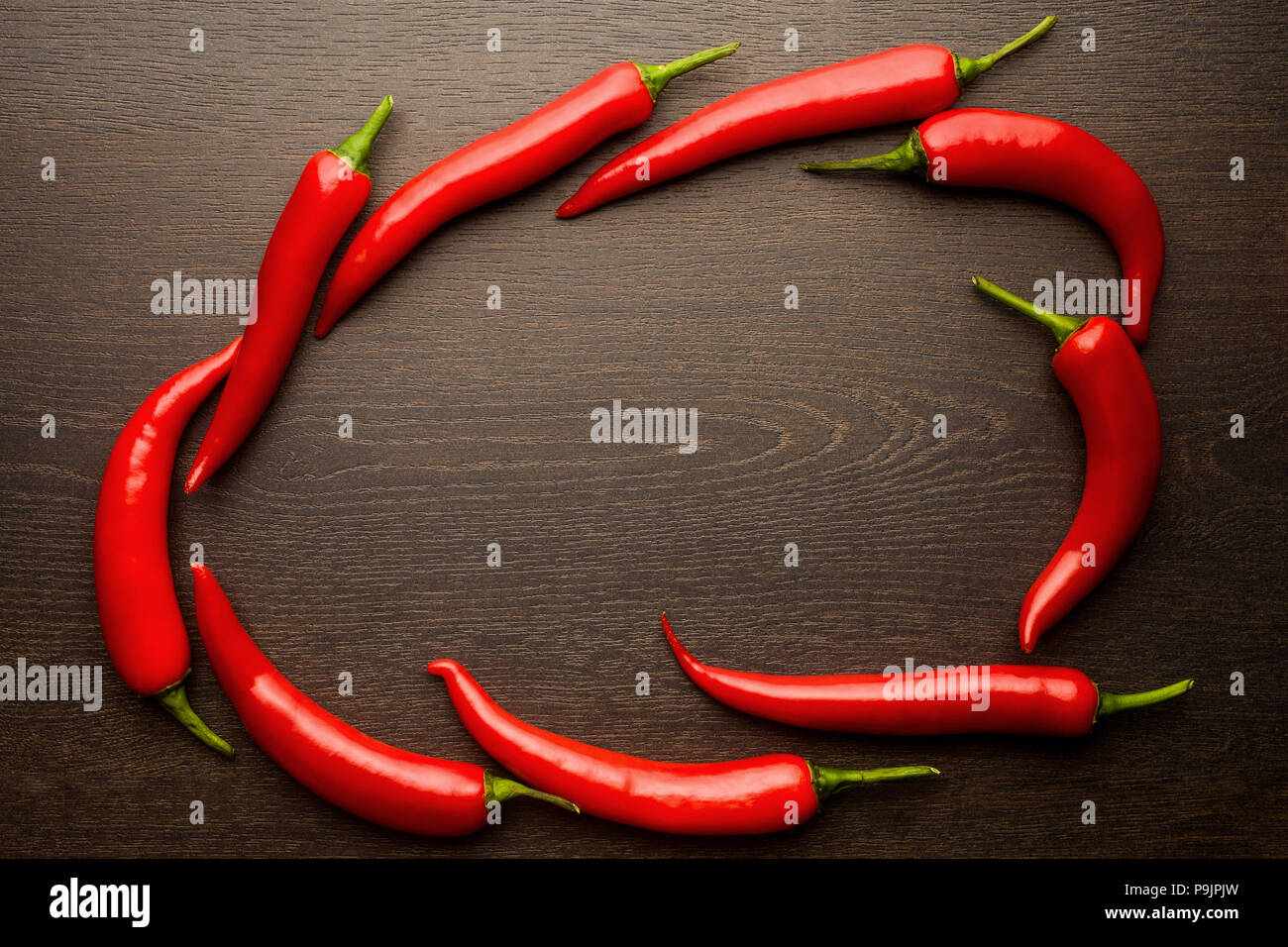 bunch fresh raw red hot chilli pepper on a wooden background tie Stock ...