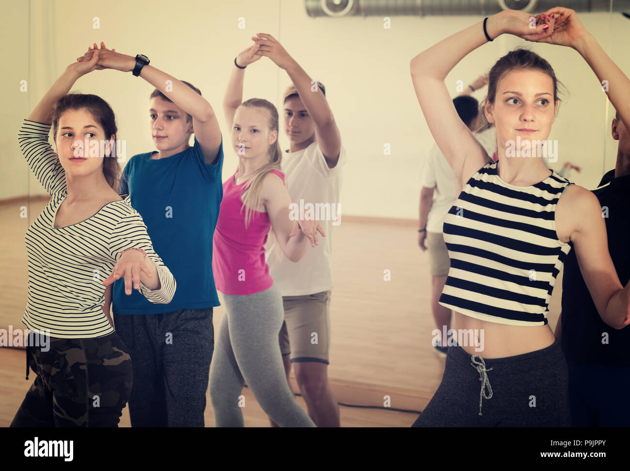 Teen boys and girls having dancing class in dance studio Stock Photo ...