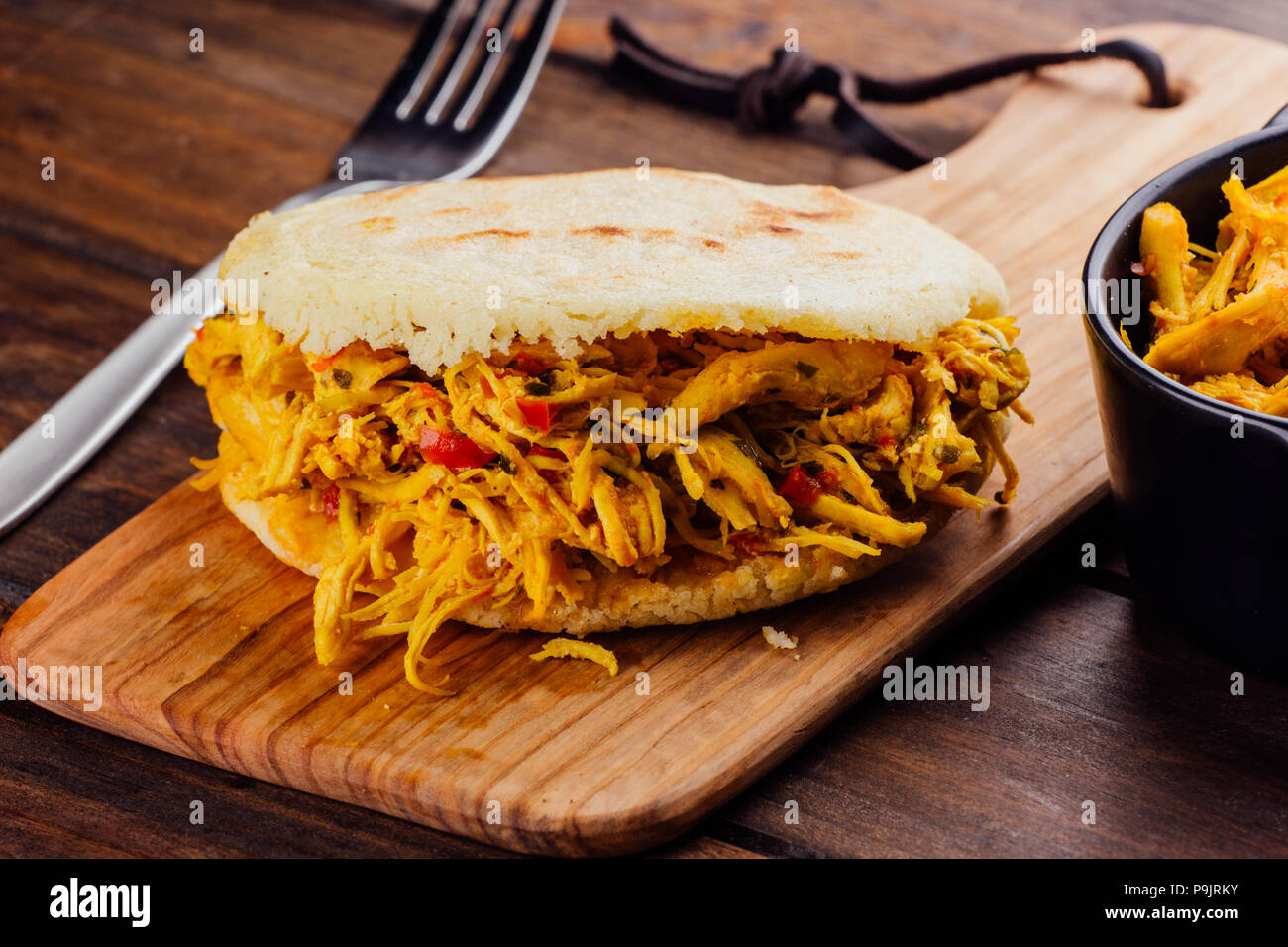 Typical South American breakfast, arepa with roasted chicken on table ...