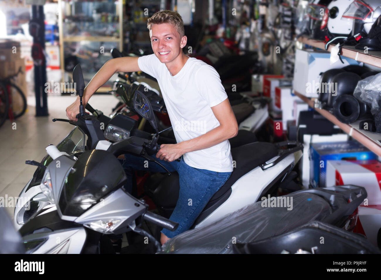 Customer male is sitting on the motorbike in the motorcycle store Stock ...