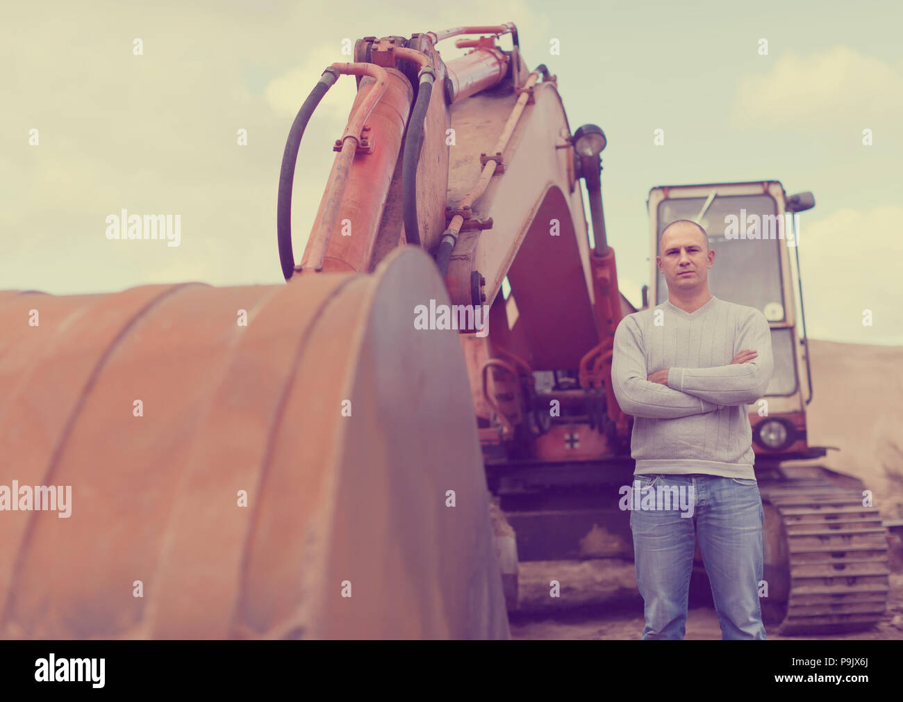 Portrait of tractor operator at sand pit Stock Photo - Alamy