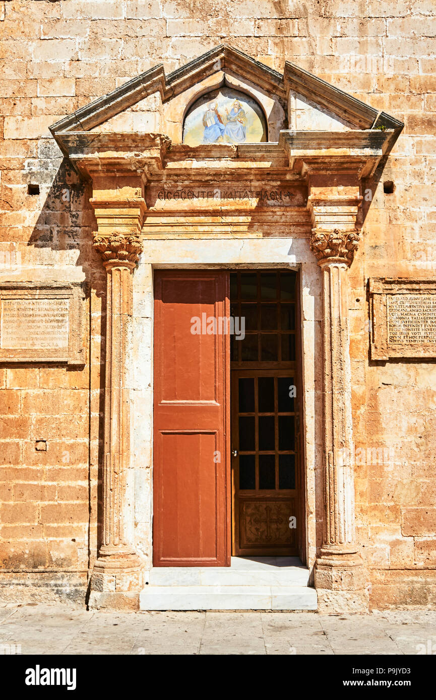 Stone portal and wooden door of an Orthodox monastery on the island of ...