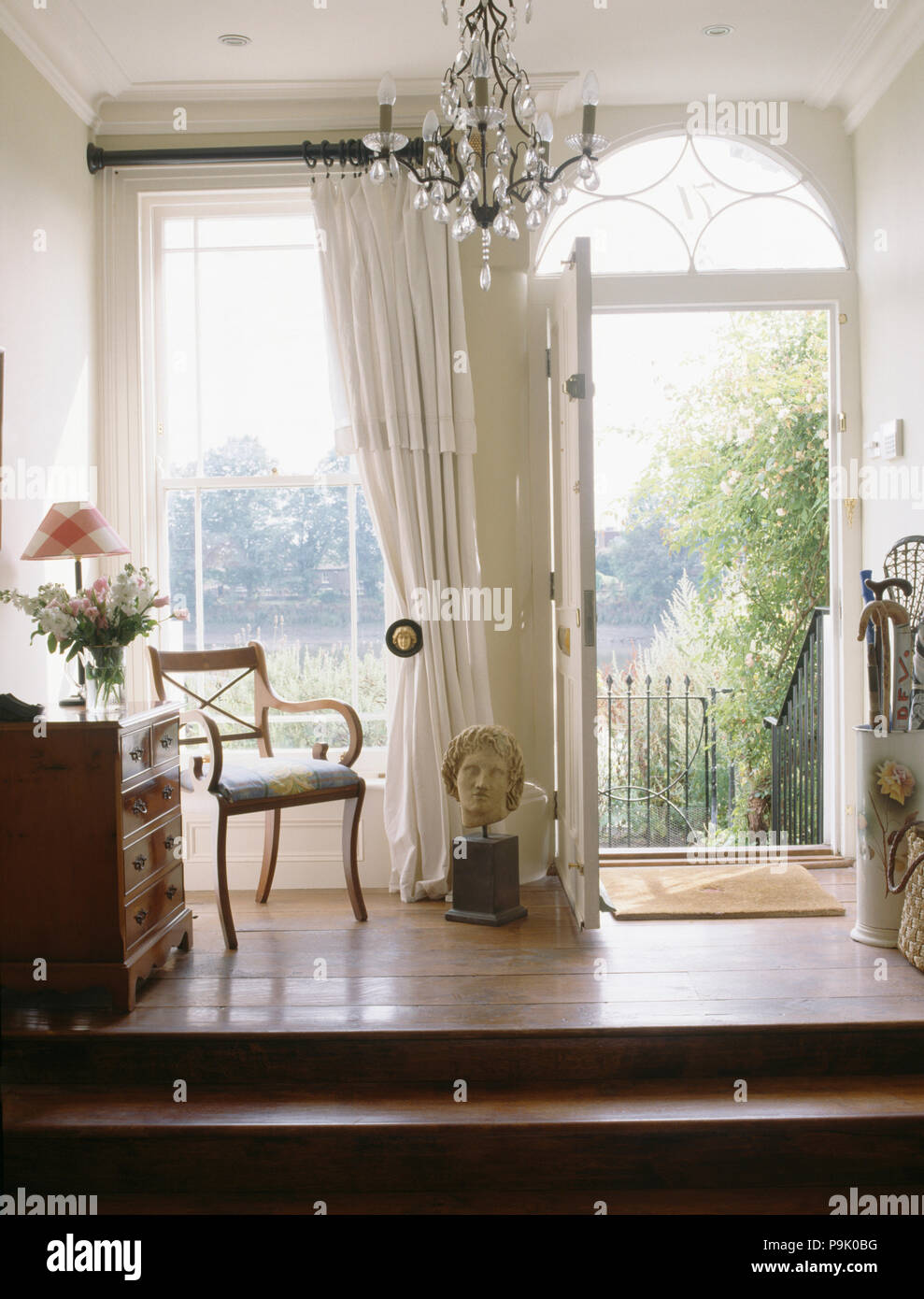 Traditional white hall with open front door Stock Photo - Alamy