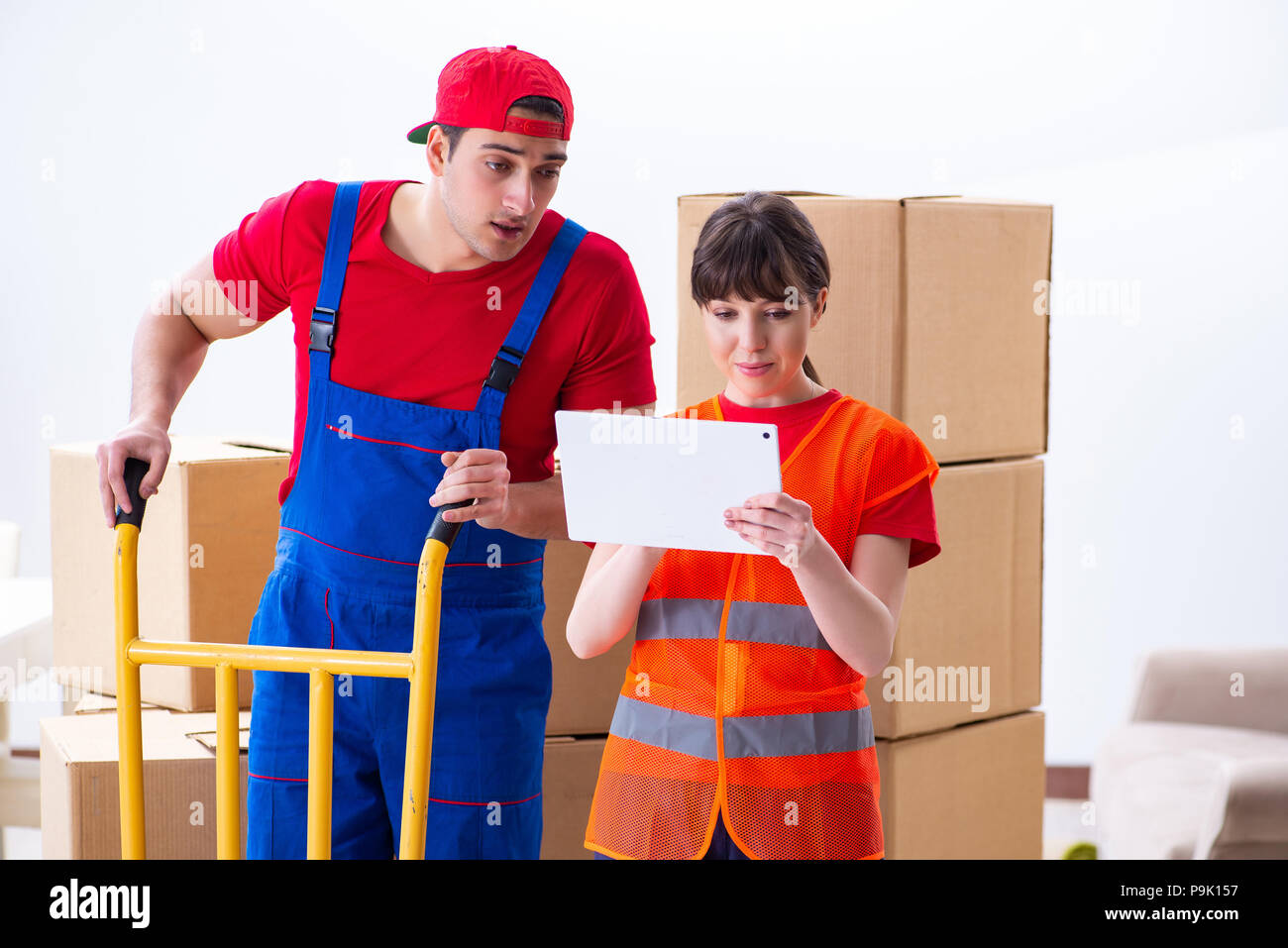 Professional movers doing home relocation Stock Photo - Alamy