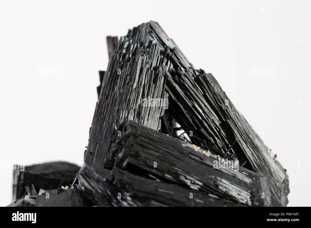 Extreme close up of black tourmaline mineral isolated over white ...