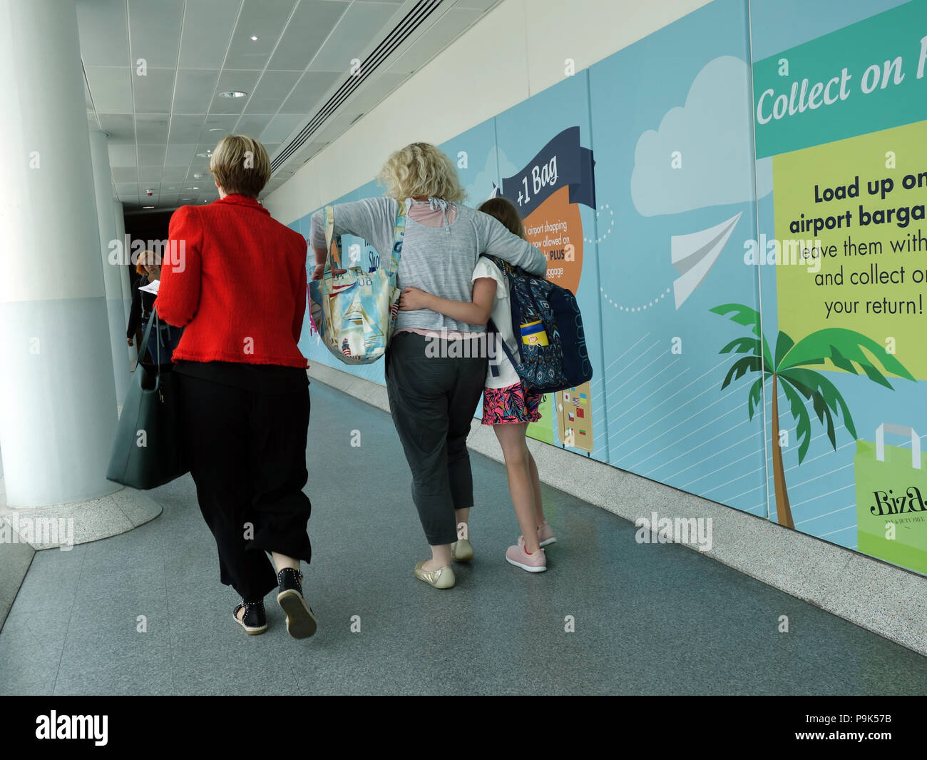 Passengers walking past the advertising on walls making their way to ...