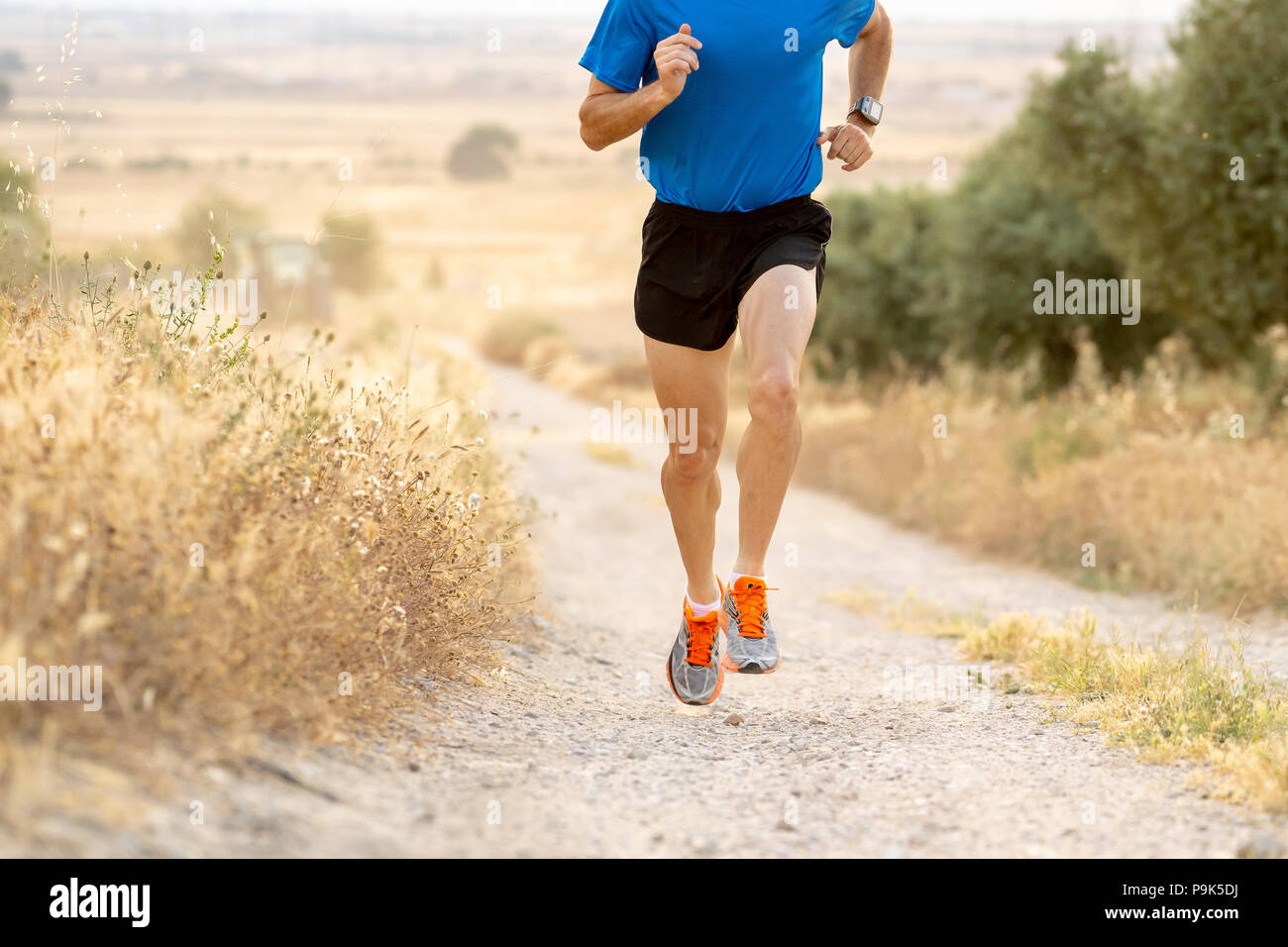 close up man runner legs and feet of extreme cross country man running ...