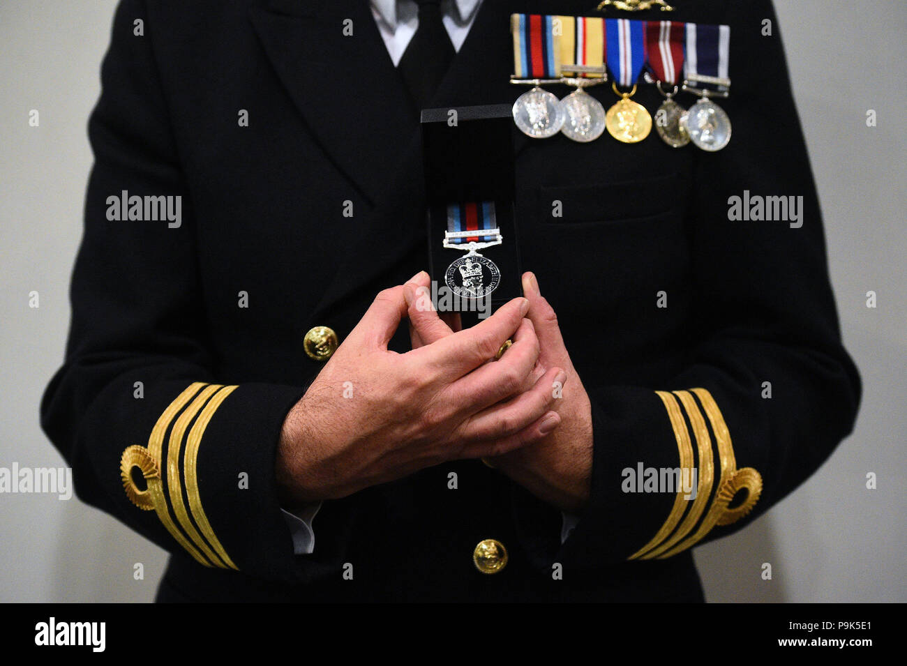 A serviceman holds his new Operation Shader medal, which was presented ...