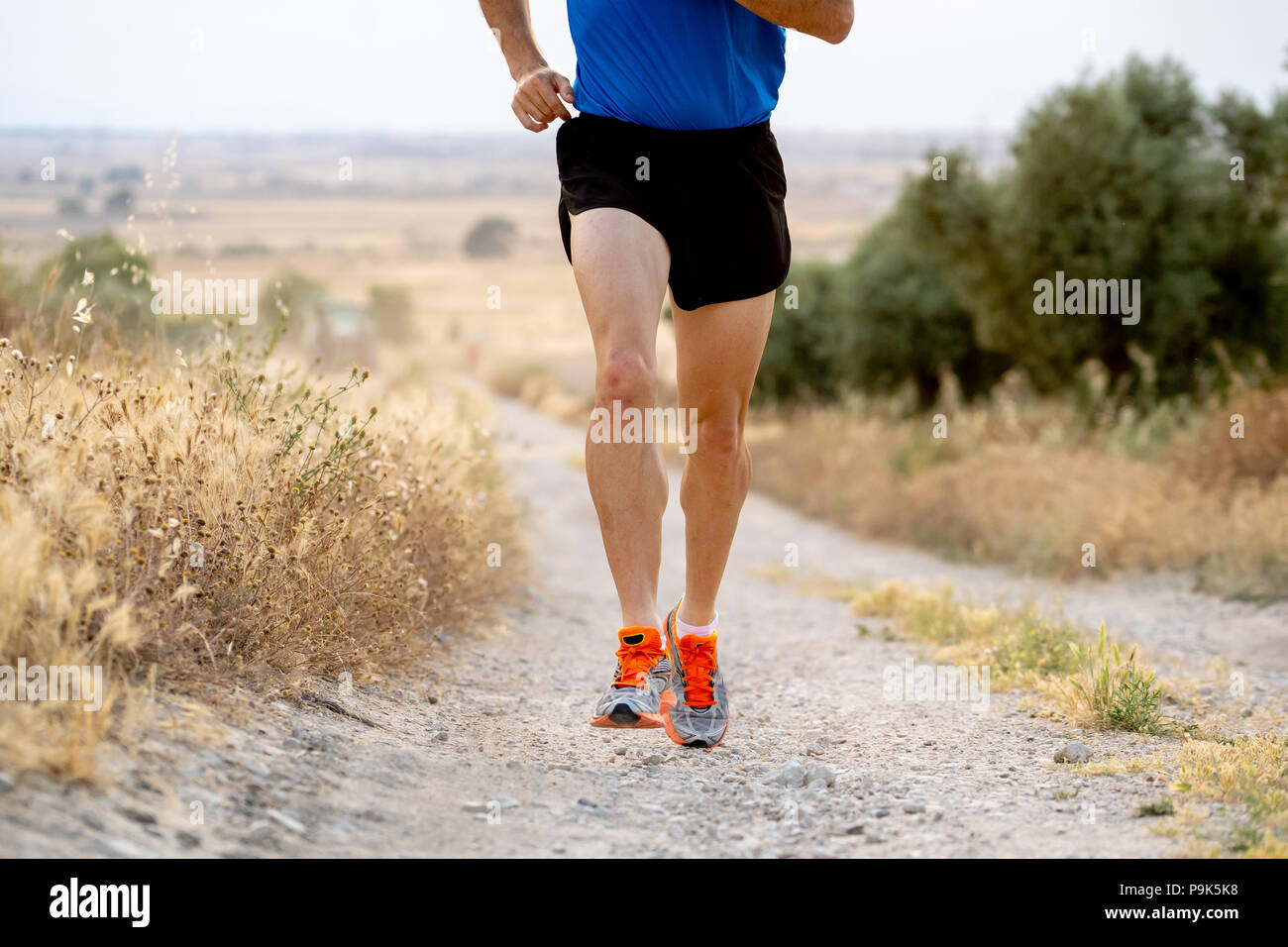 close up man runner legs and feet of extreme cross country man running ...