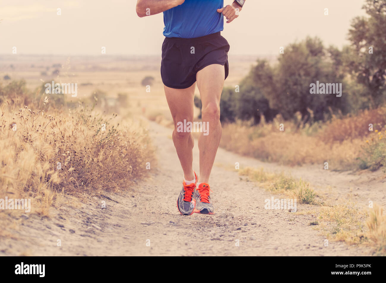 close up man runner legs and feet of extreme cross country man running ...