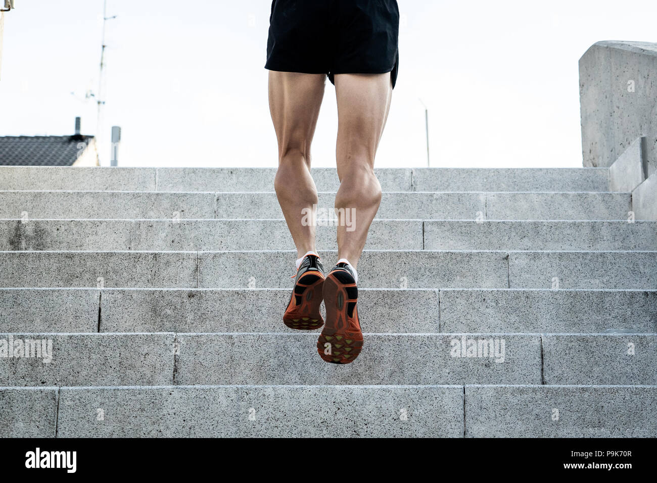 Man runner running on stairs in urban city sport training young male ...