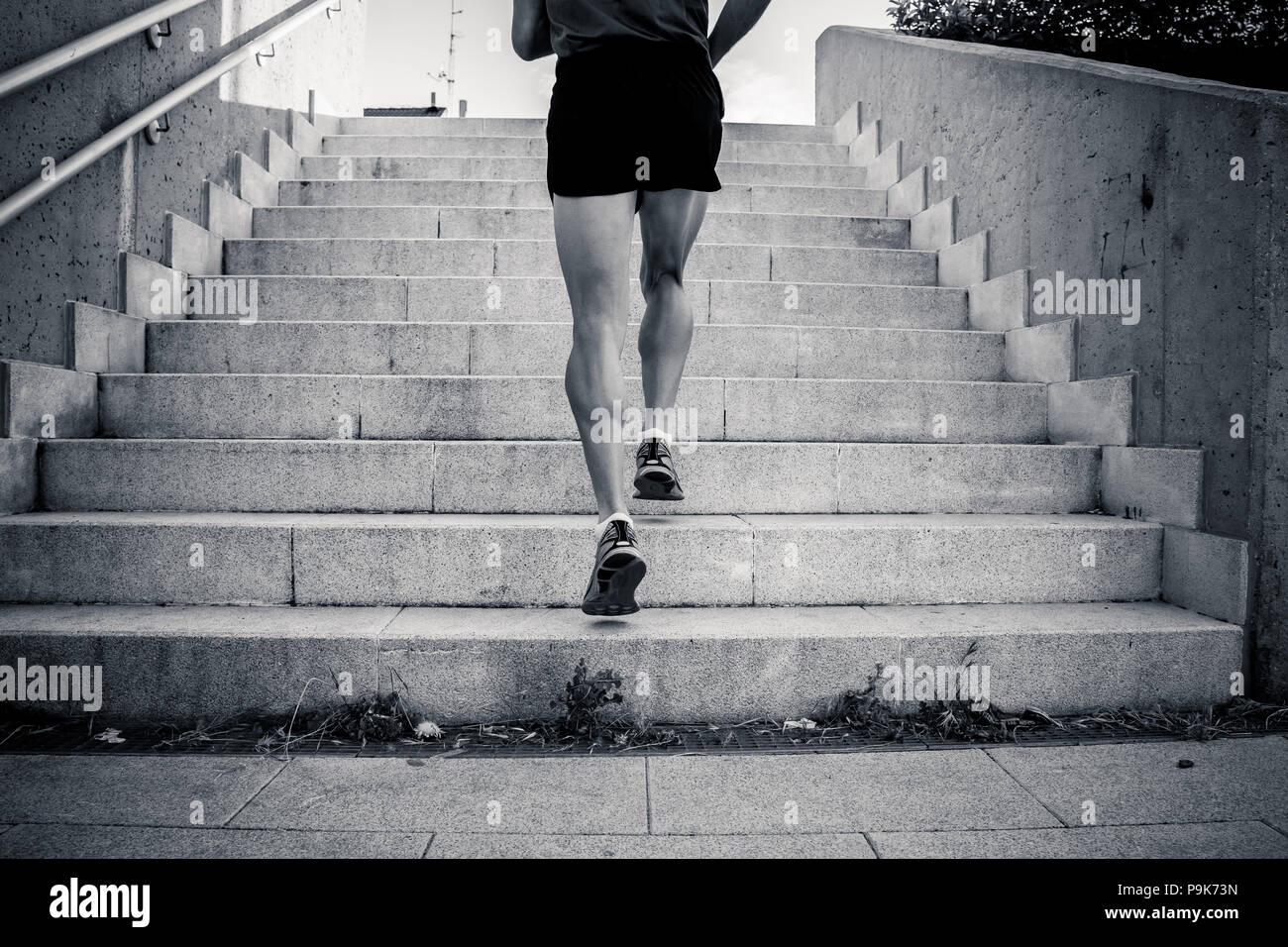 Black and white man runner running on stairs in urban city sport ...