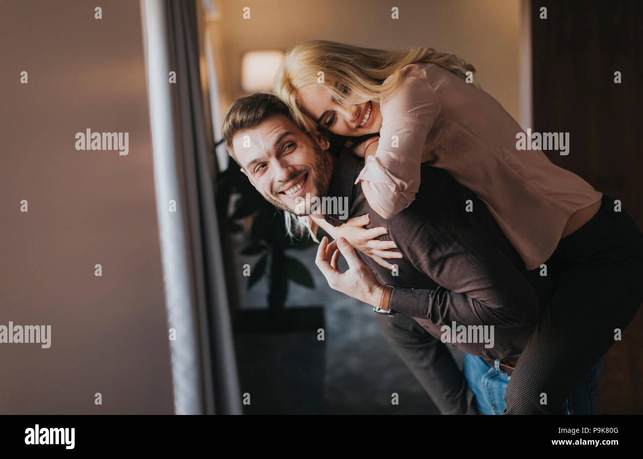 Lovely young couple having fun in the room Stock Photo - Alamy