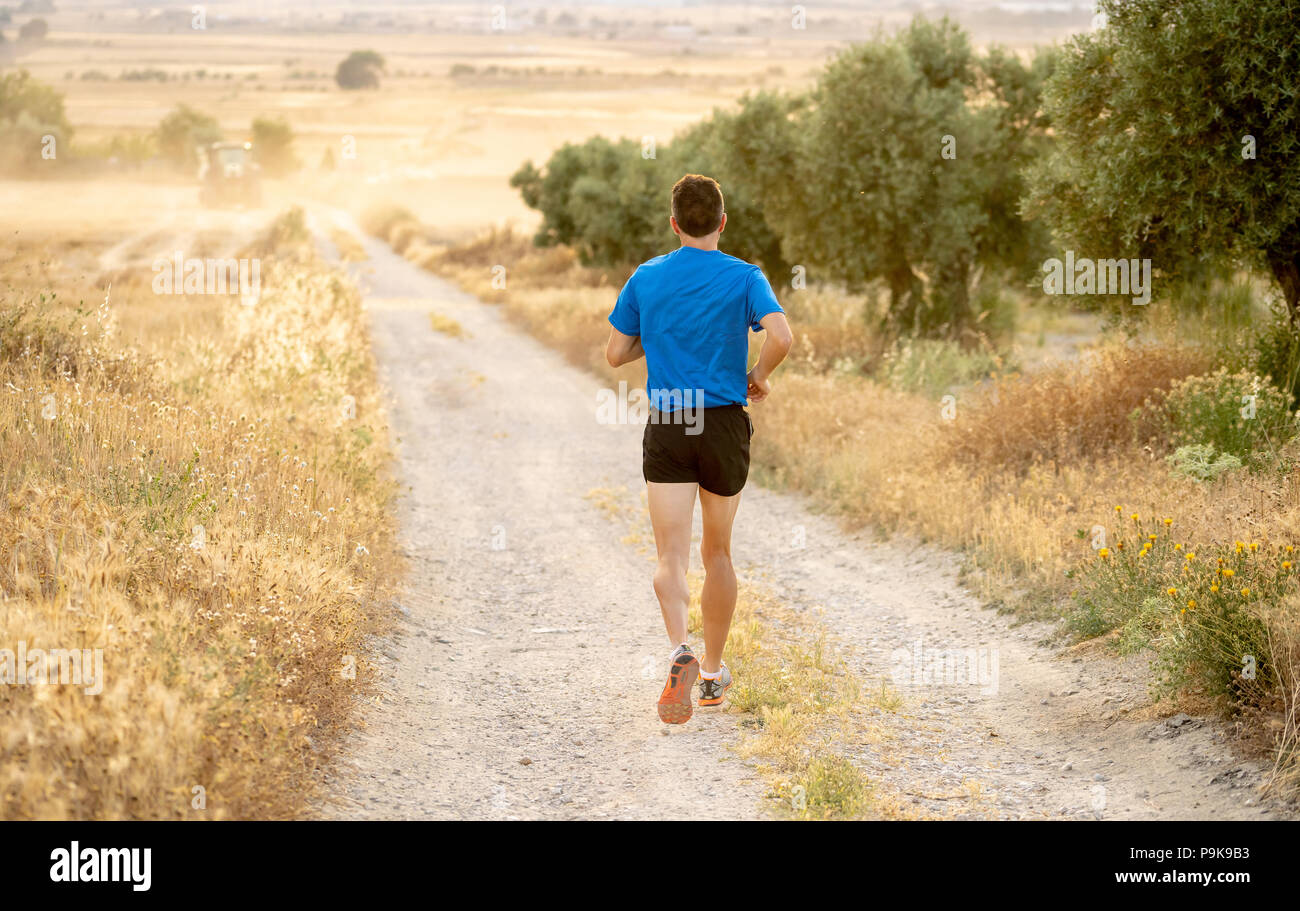 Fitness runner running extreme cross country and training on rural ...