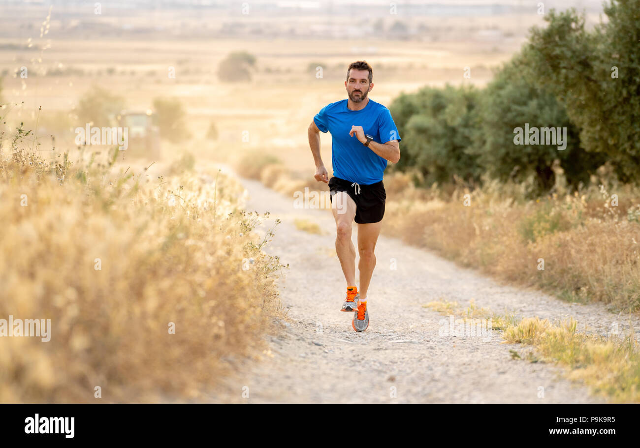 Fitness runner running extreme cross country and training on rural ...