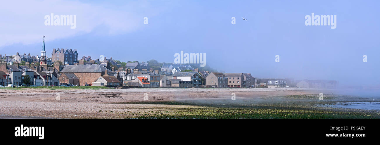 Shingle beach covered in mist and the town Stonehaven, Aberdeenshire ...