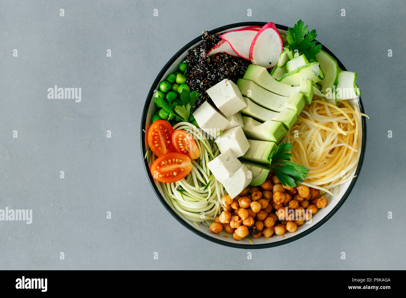 Bowl of buddha with spiralized vegetables on gray concrete background ...