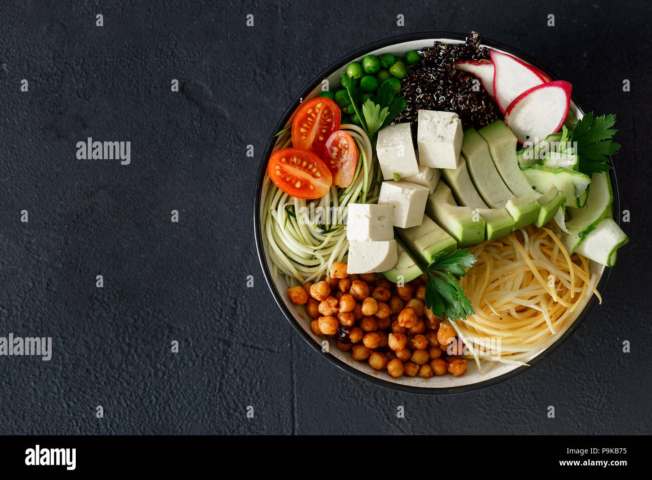 Bowl of buddha with spiralized vegetables on dark background with copy ...