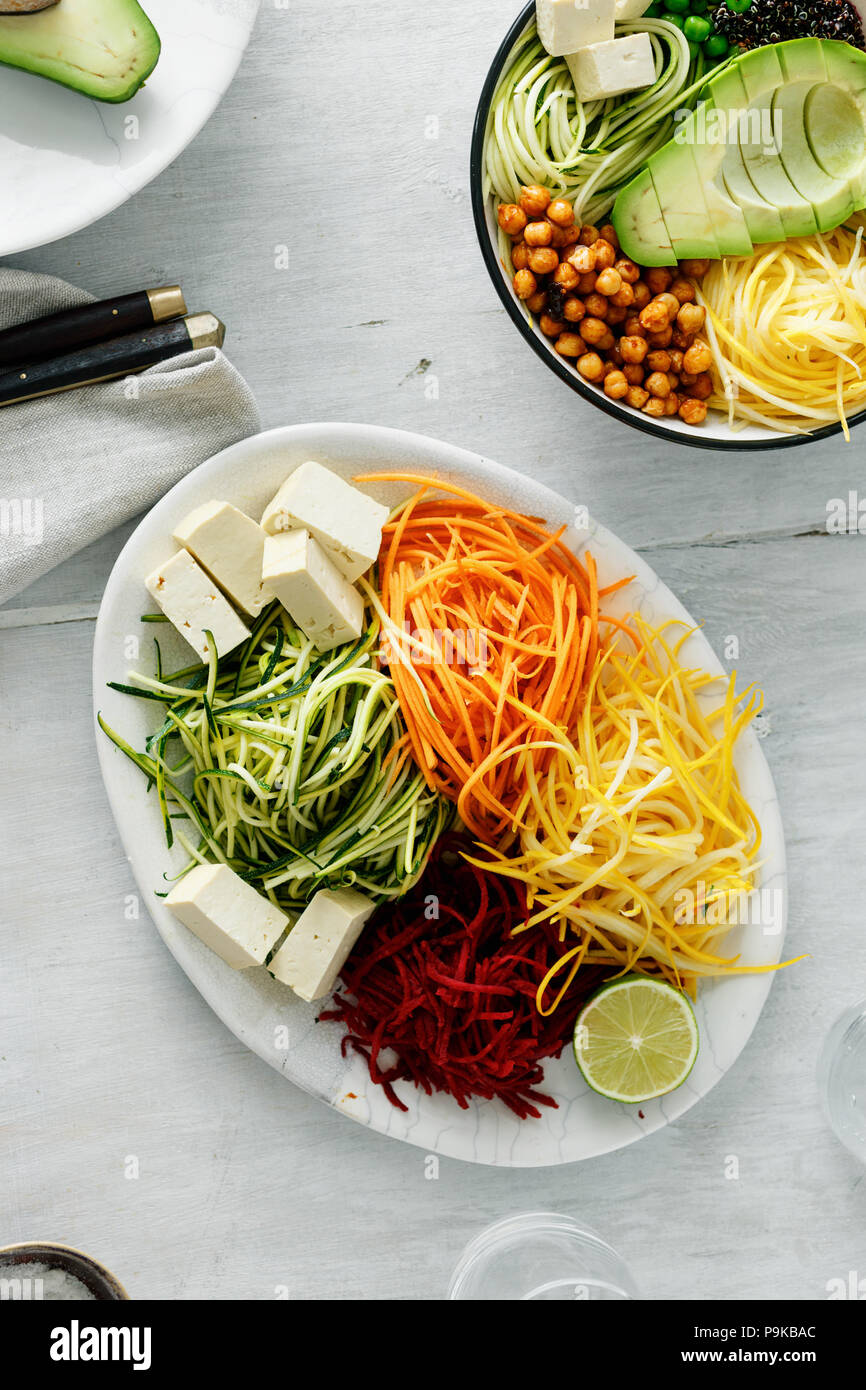 Bowl of buddha with spiralized vegetables on white wooden table, top ...