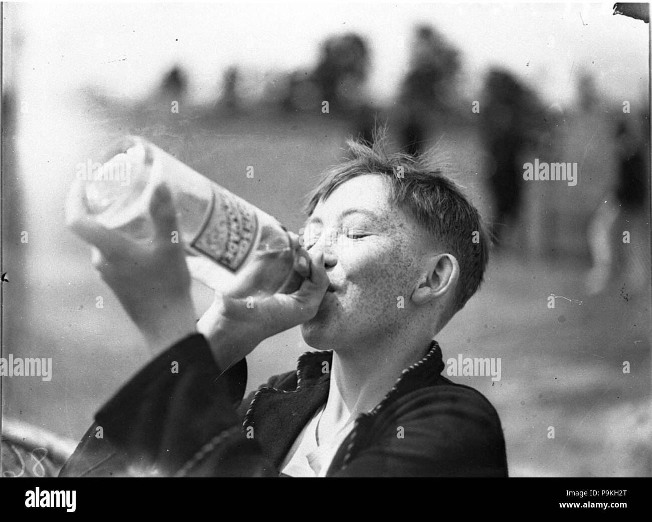 264 SLNSW 42781 Boy drinking softdrink from bottle at school sports ...