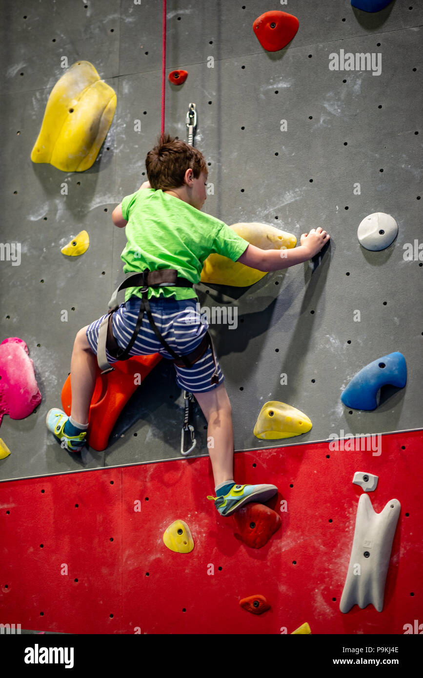 Young boy rock climbing hi-res stock photography and images - Alamy