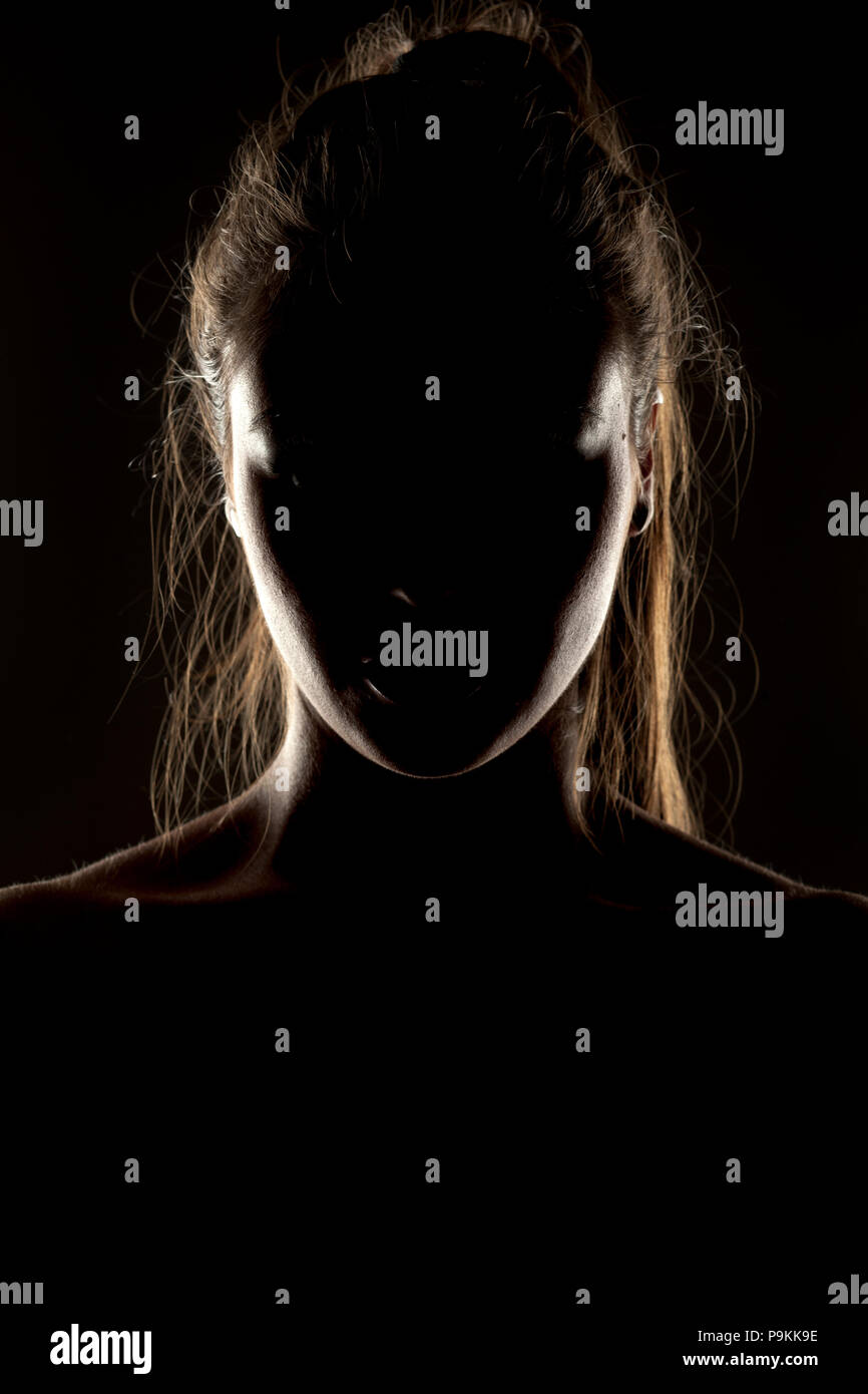 Mysterious portrait of woman in shadow on dark background Stock Photo ...