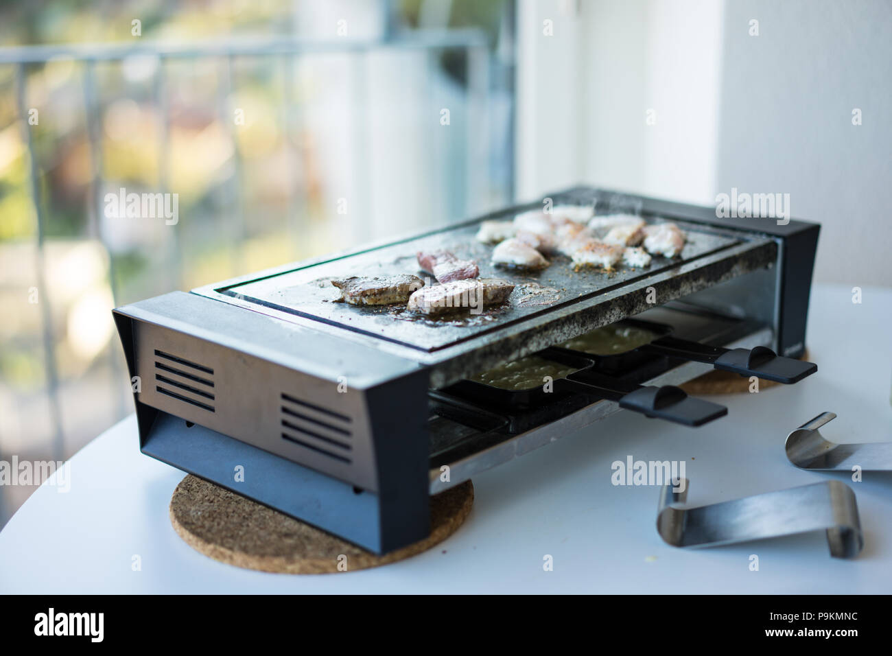 meat and cheese on table grill raclette food dish Stock Photo - Alamy