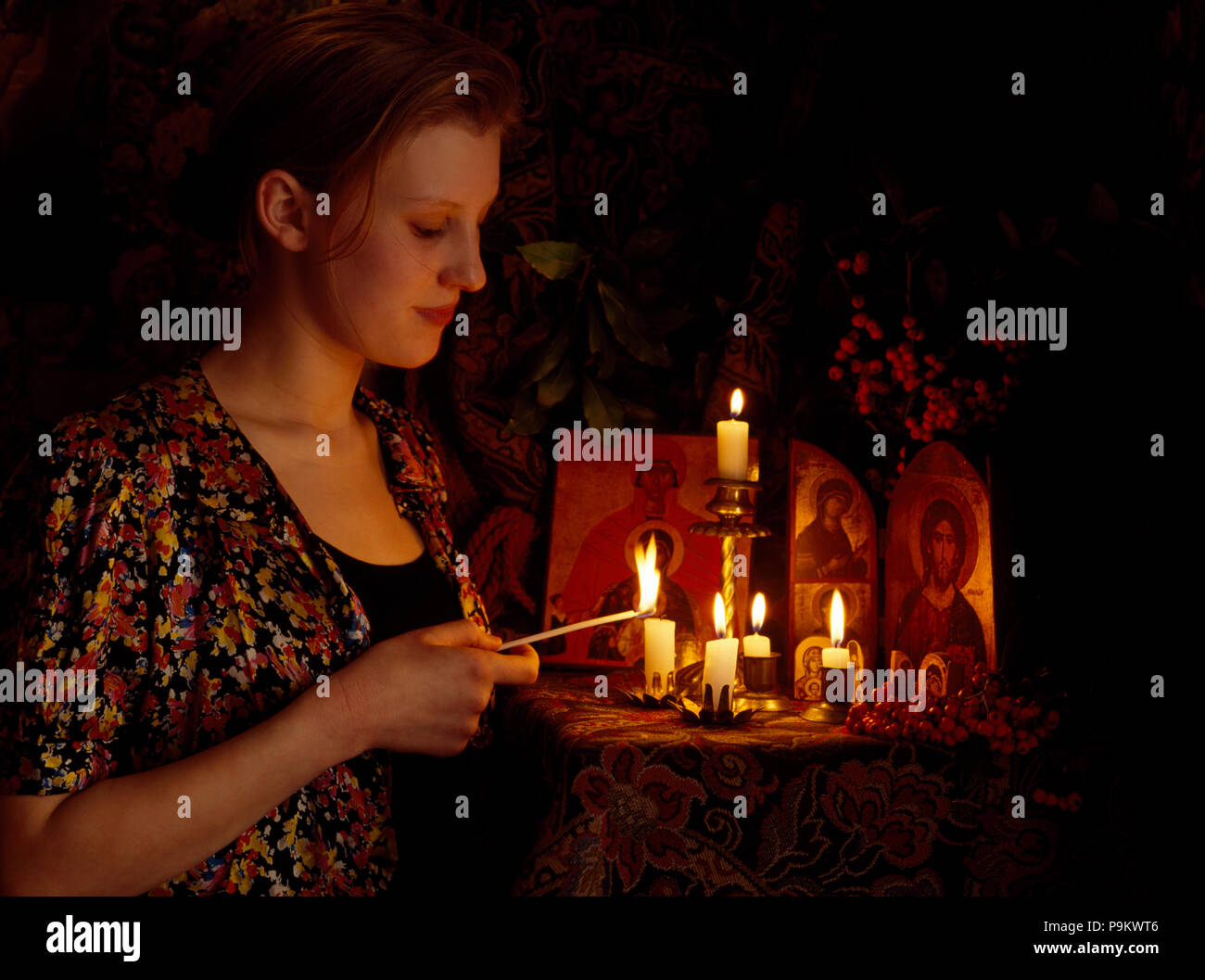 Young girl lighting Christmas candles FOR EDITORIAL USE ONLY Stock ...