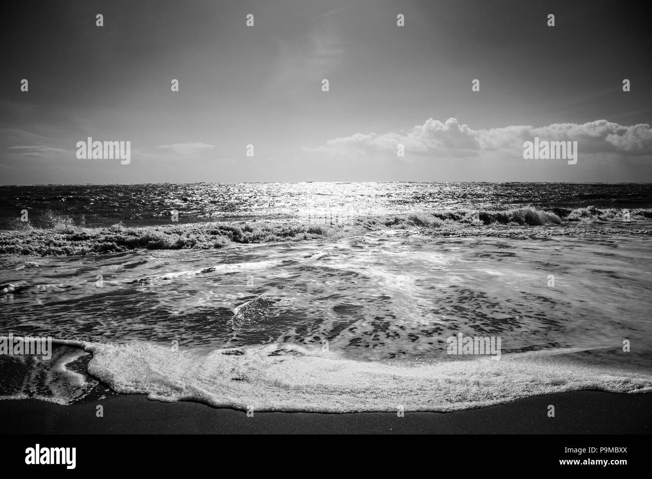 The tide coming in on the beach Stock Photo - Alamy