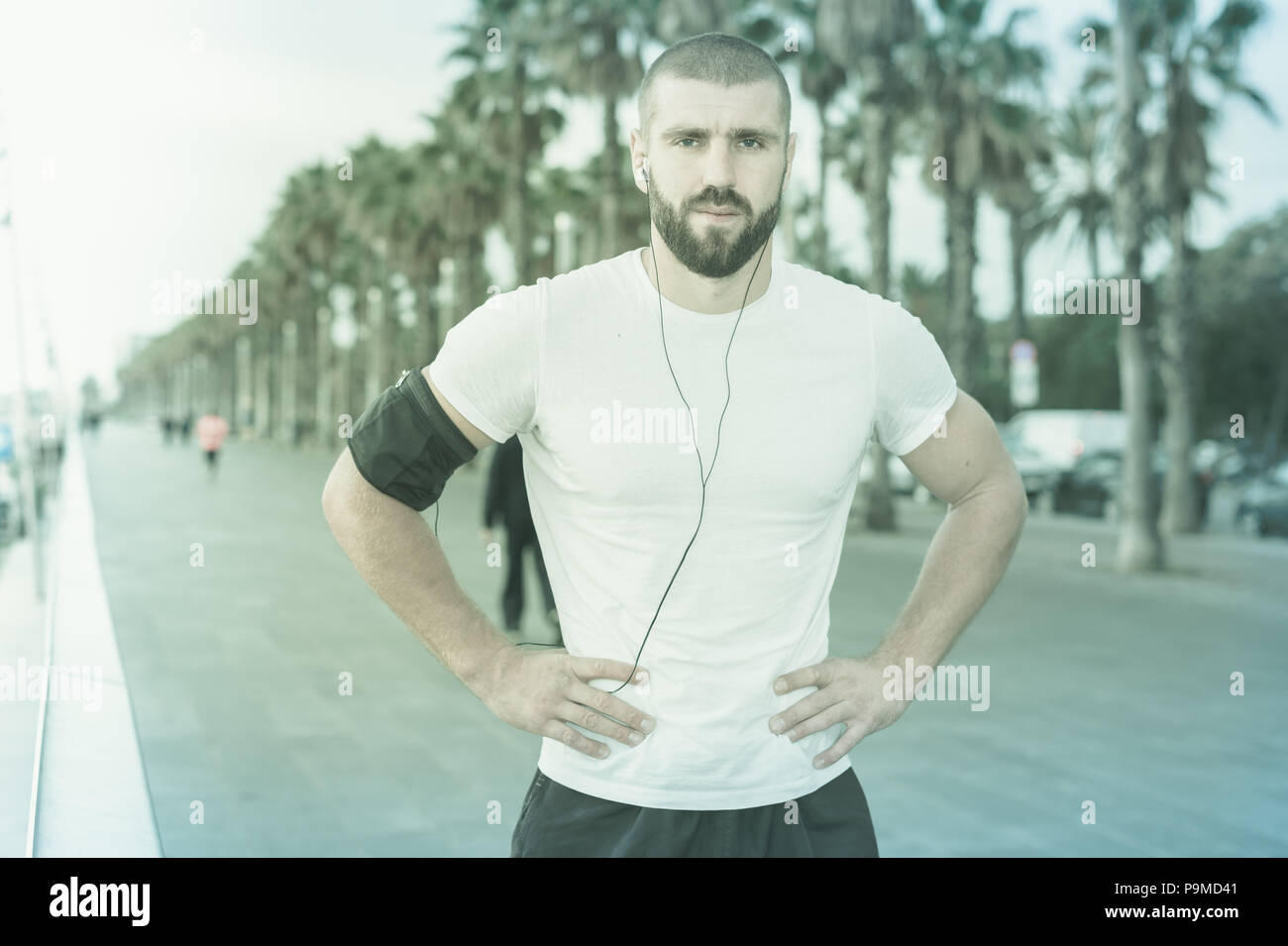 Athletic male stopped to rest while running Stock Photo - Alamy