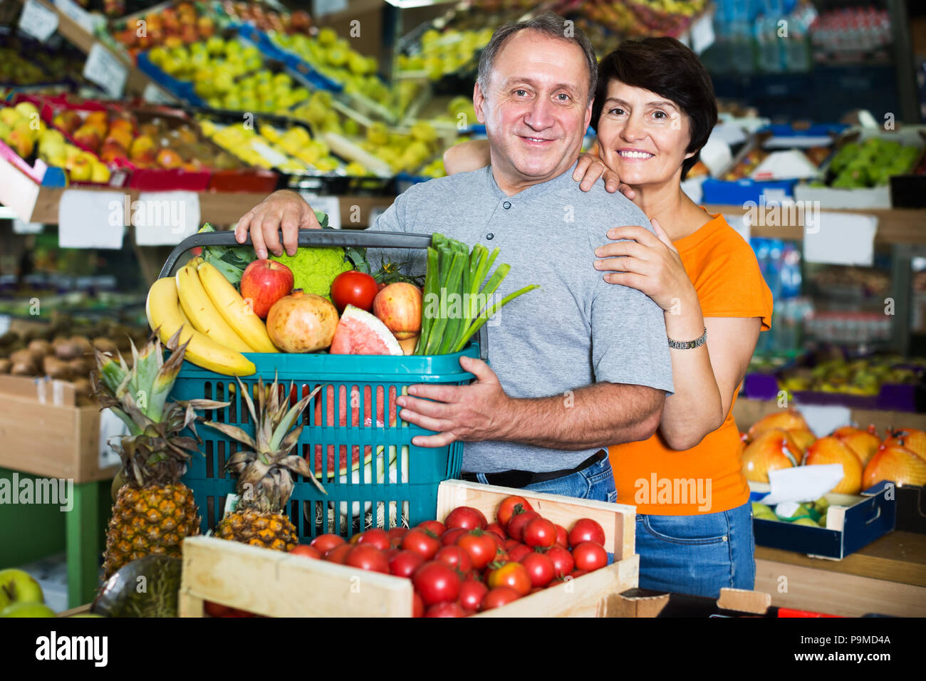 Man and his wife are demonstraiting basket with variety goods in ...