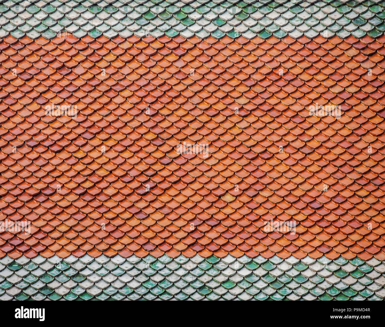 Dichromatic brick roof tiles on roof of a country house of Thailand ...
