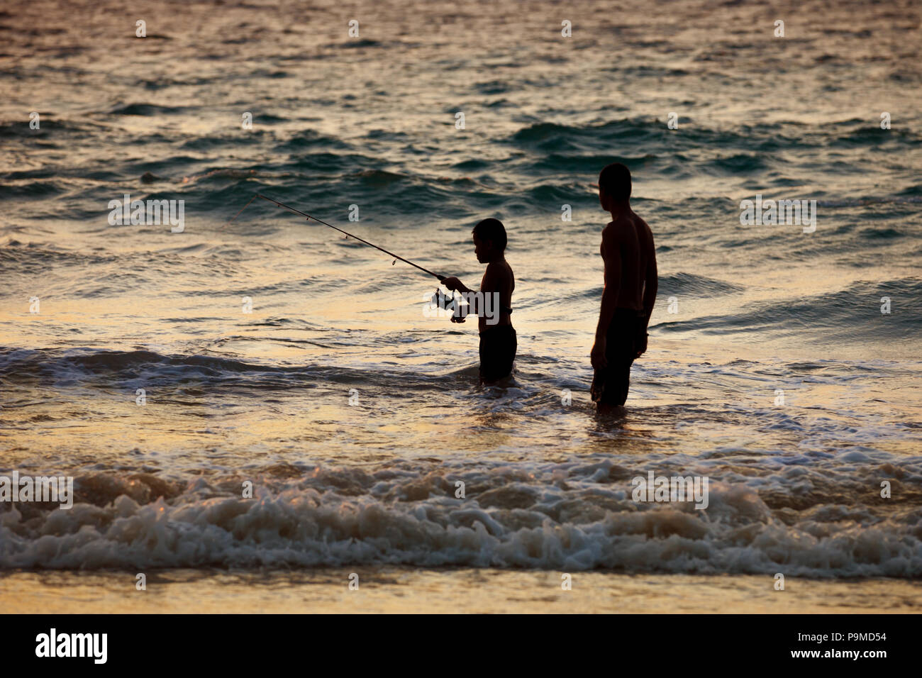 PHUKET, THAILAND - CIRCA MAR 2013: Thai fisher boy, with his father on ...
