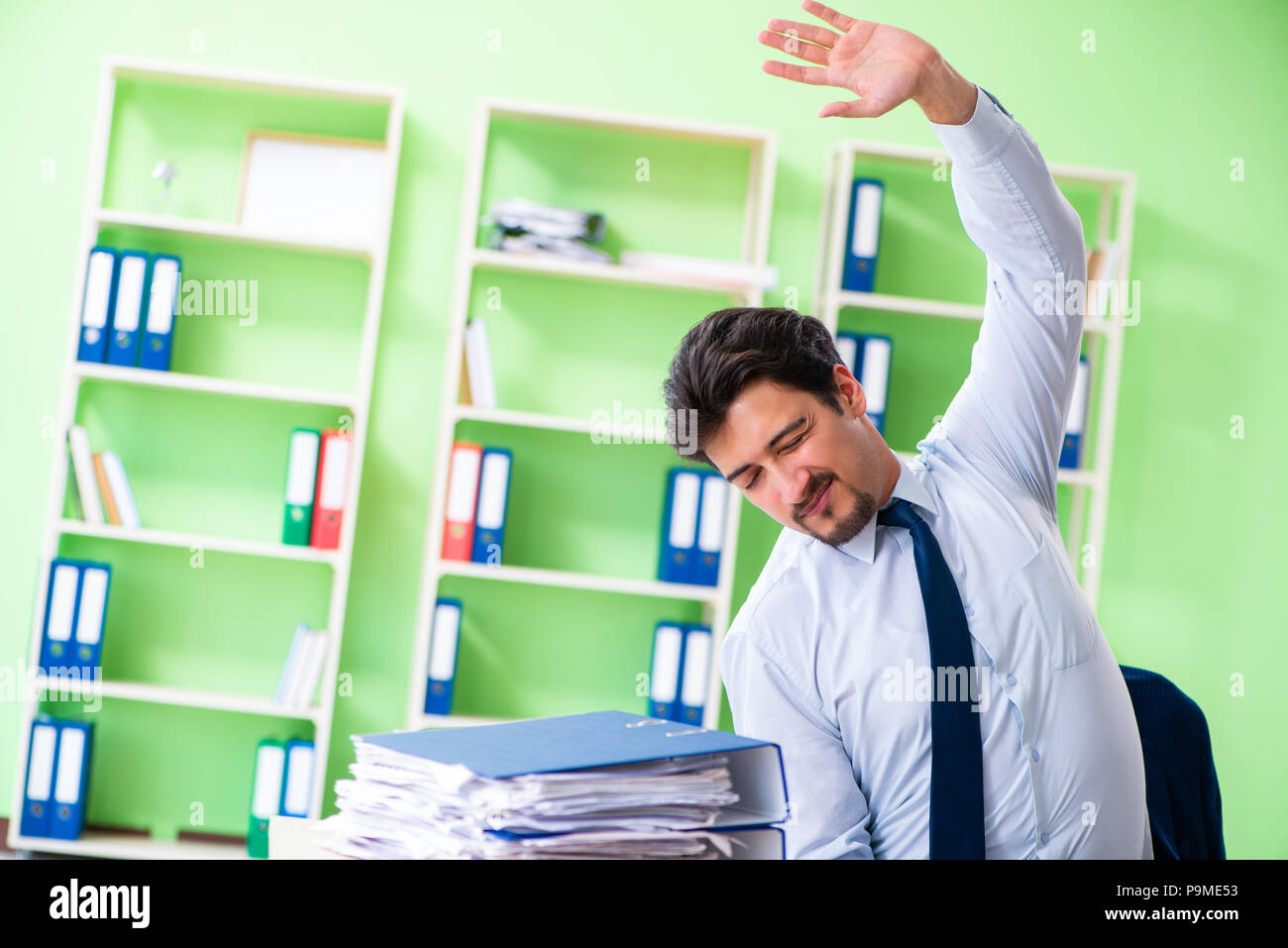 Employee doing exercises during break at work Stock Photo - Alamy