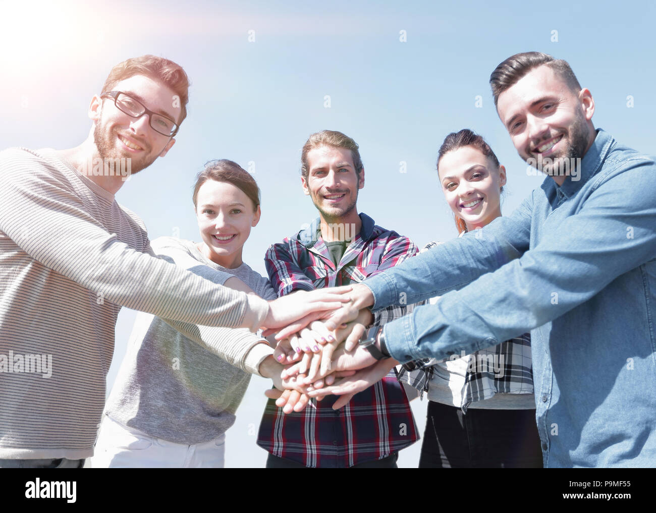 Standing friends joined hands hi-res stock photography and images - Alamy