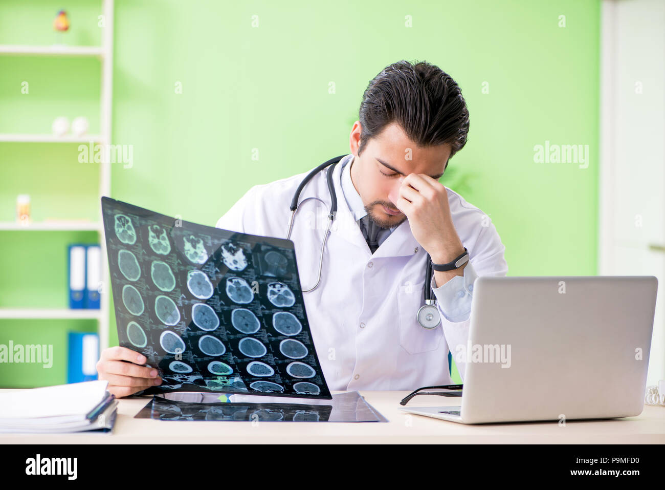Doctor radiologist looking at x-ray scan in hospital Stock Photo - Alamy