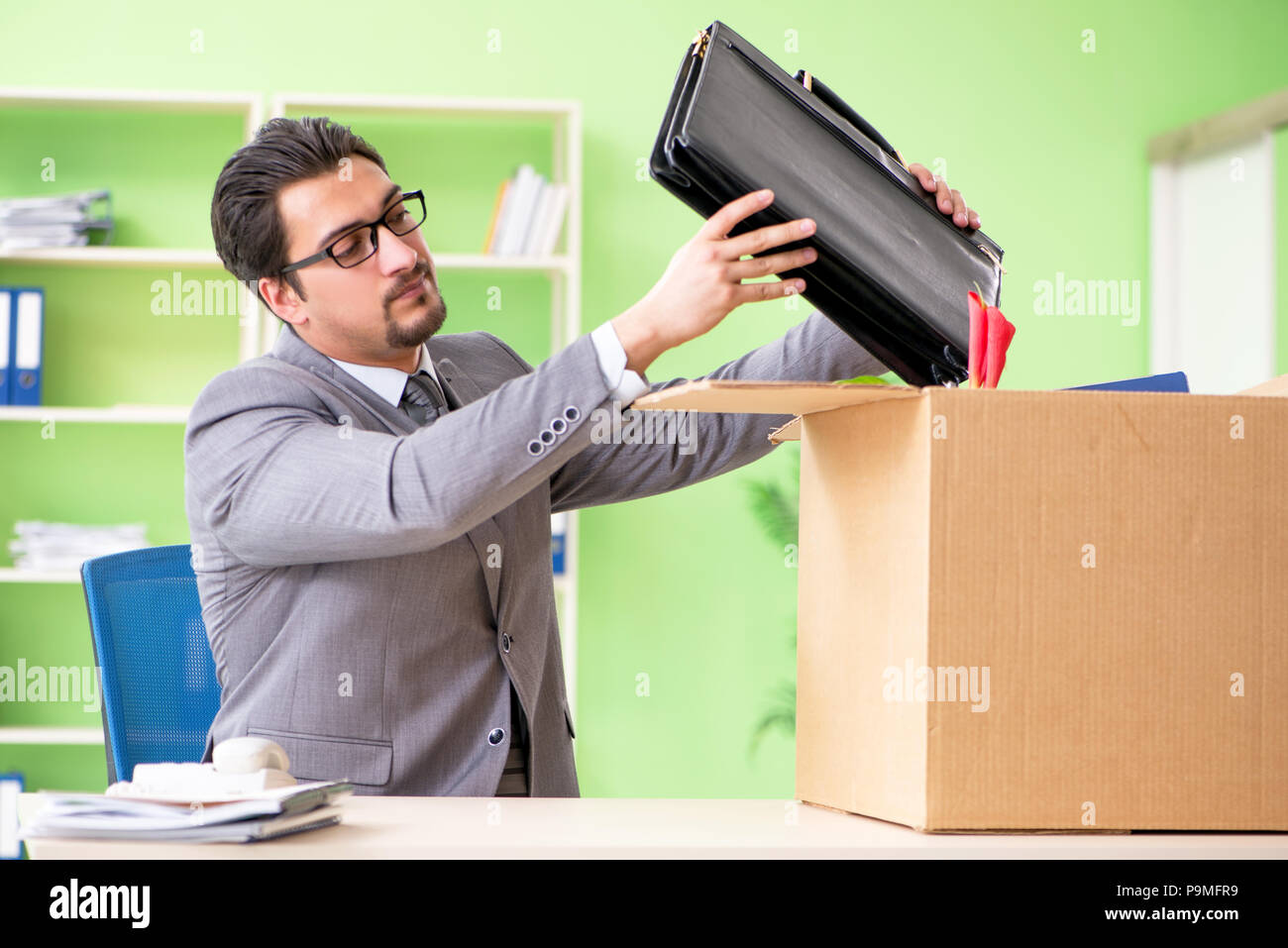 Male employee collecting his stuff after redundancy Stock Photo - Alamy