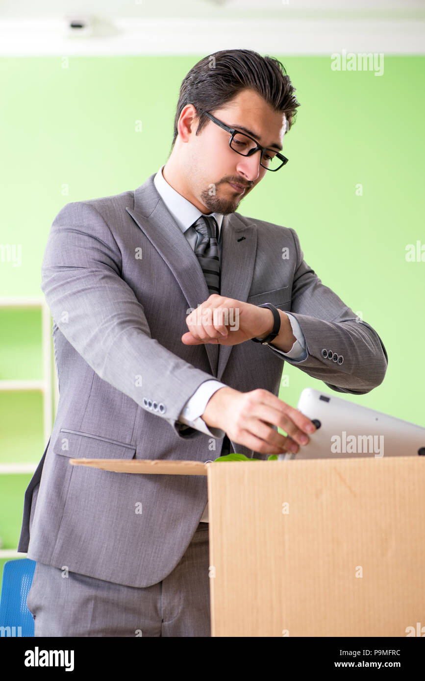 Male employee collecting his stuff after redundancy Stock Photo - Alamy