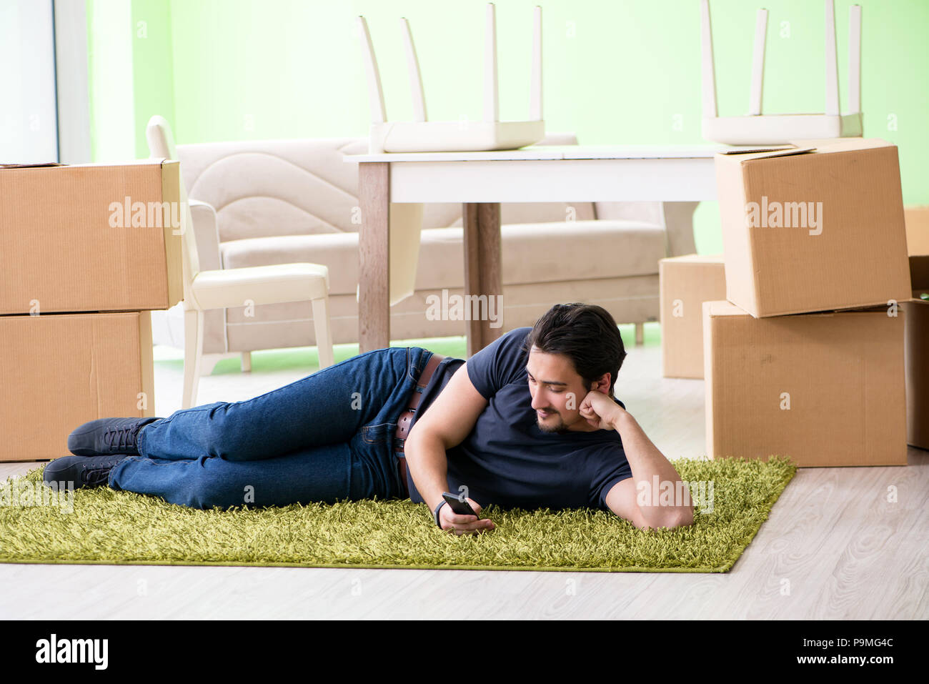 Man moving house with boxes Stock Photo - Alamy