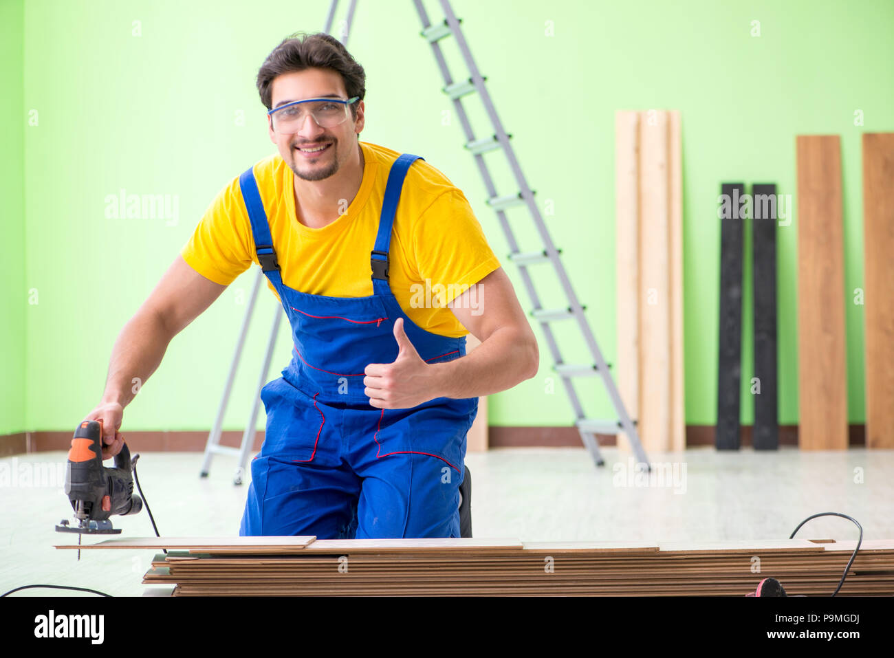 Professional contractor laying flooring at home Stock Photo - Alamy