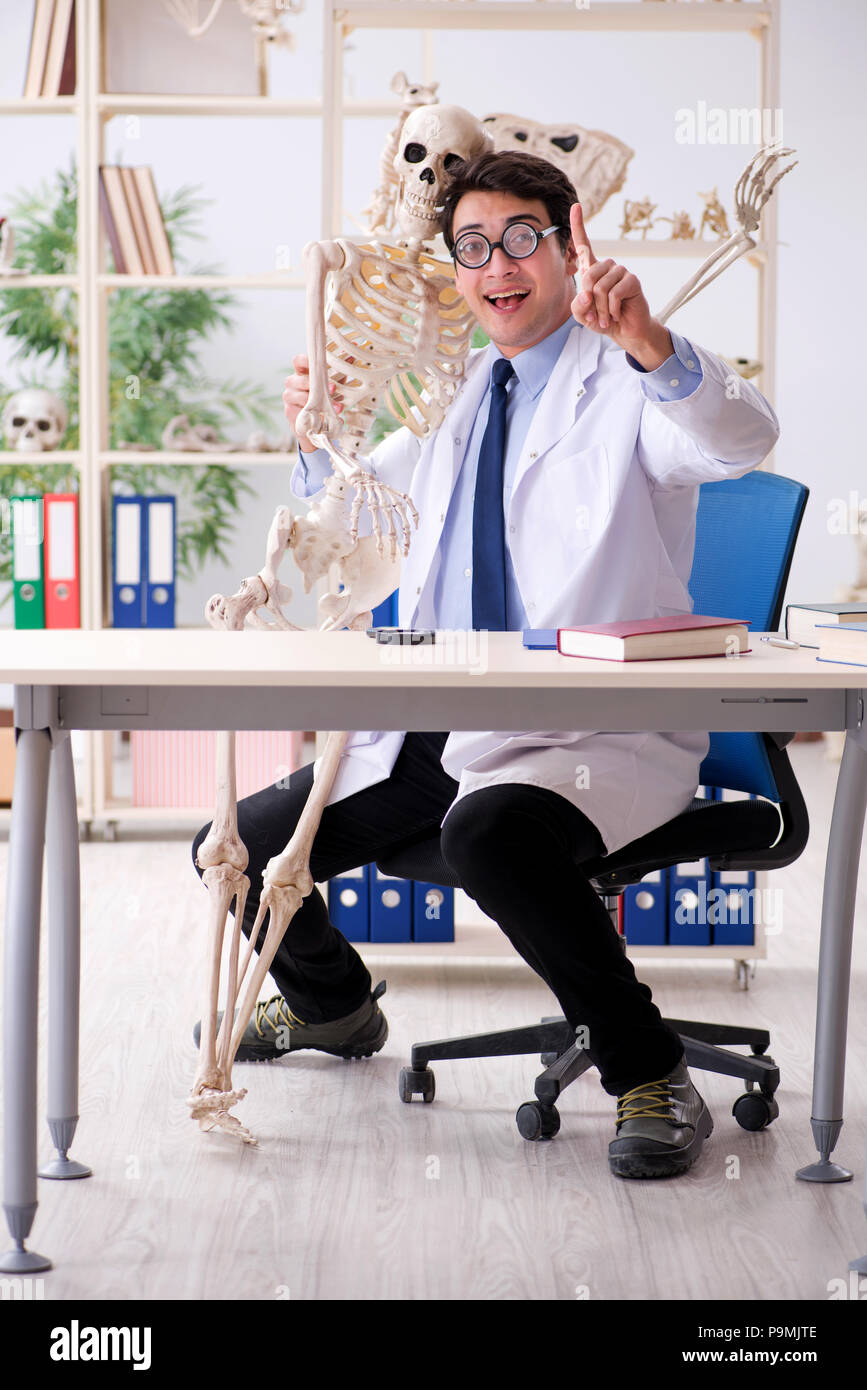Crazy professor studying human skeleton Stock Photo - Alamy