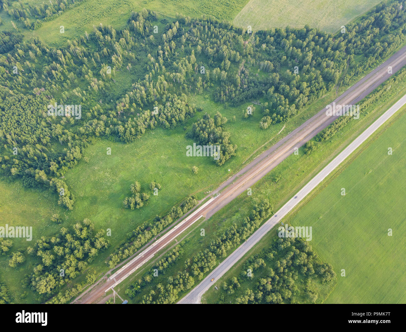 Helicopter drone shot. Aerial photography of green forest with road ...