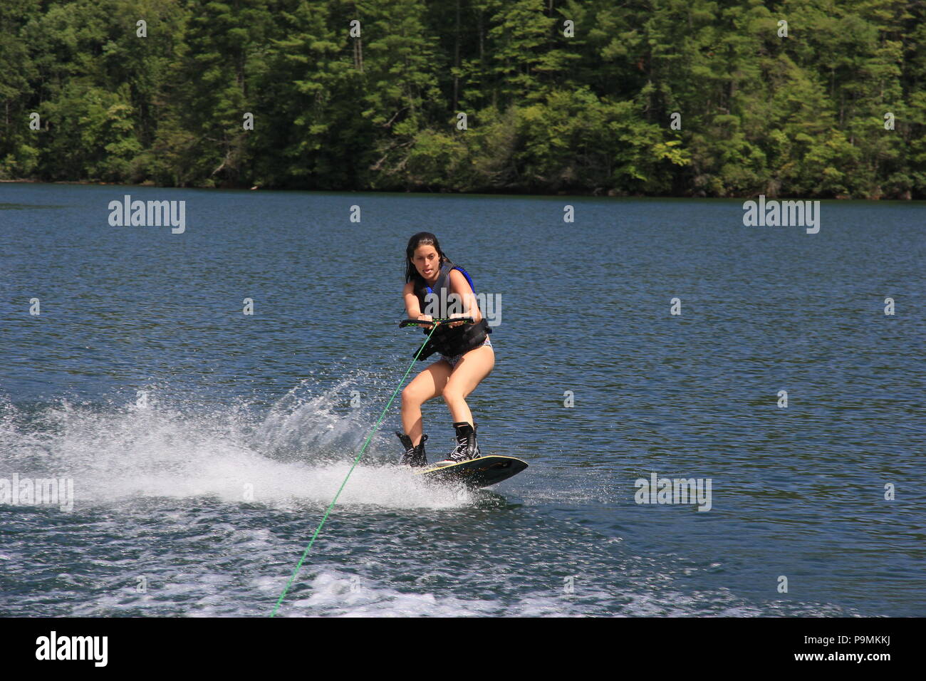 Young woman wakeboarding on Lake Santeetlah, North Carolina, United ...