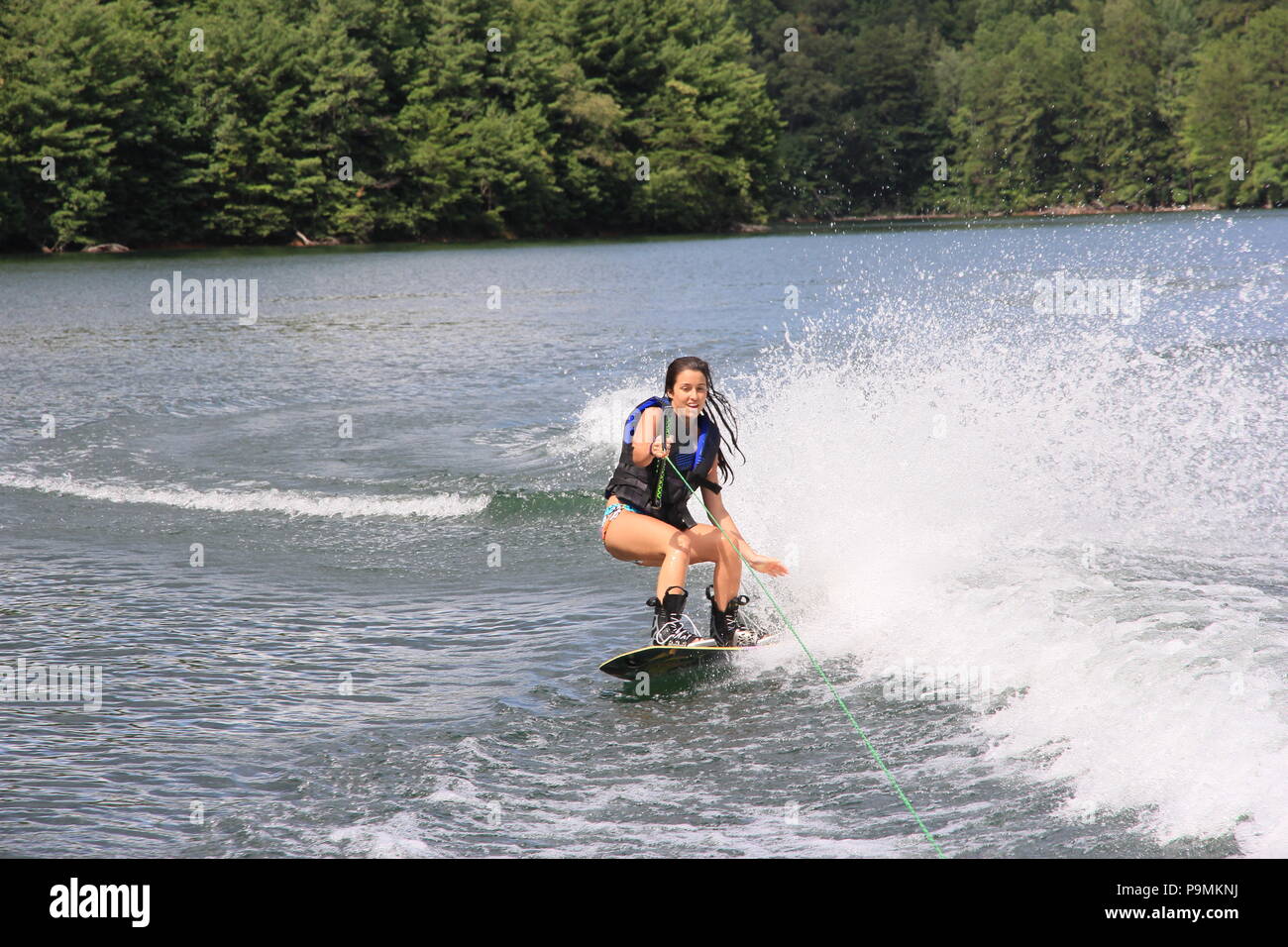 Young woman wakeboarding on Lake Santeetlah, North Carolina, United ...