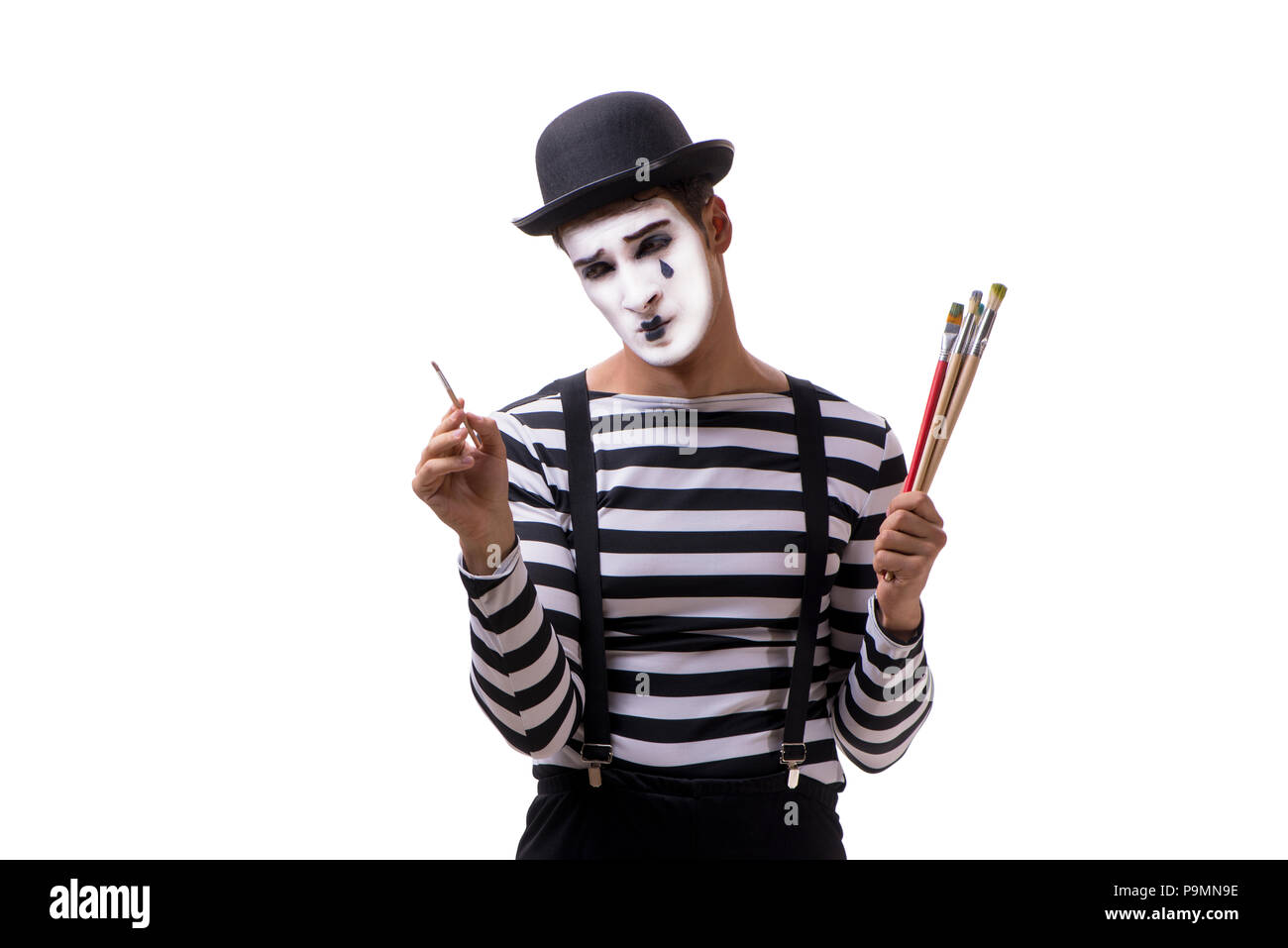 Mime holding brushes isolated on white background Stock Photo - Alamy