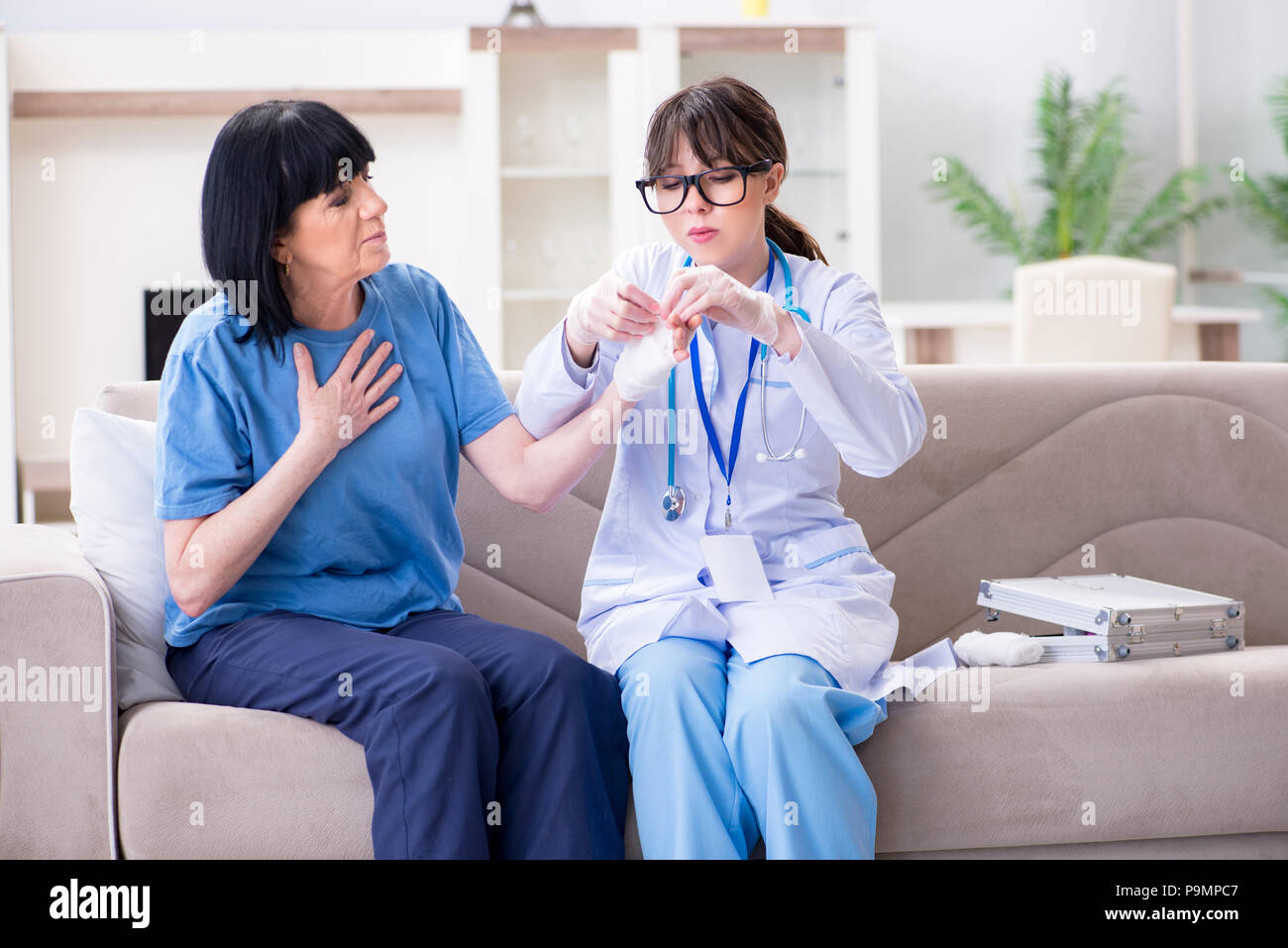 Doctor examining old mature woman after incident Stock Photo - Alamy